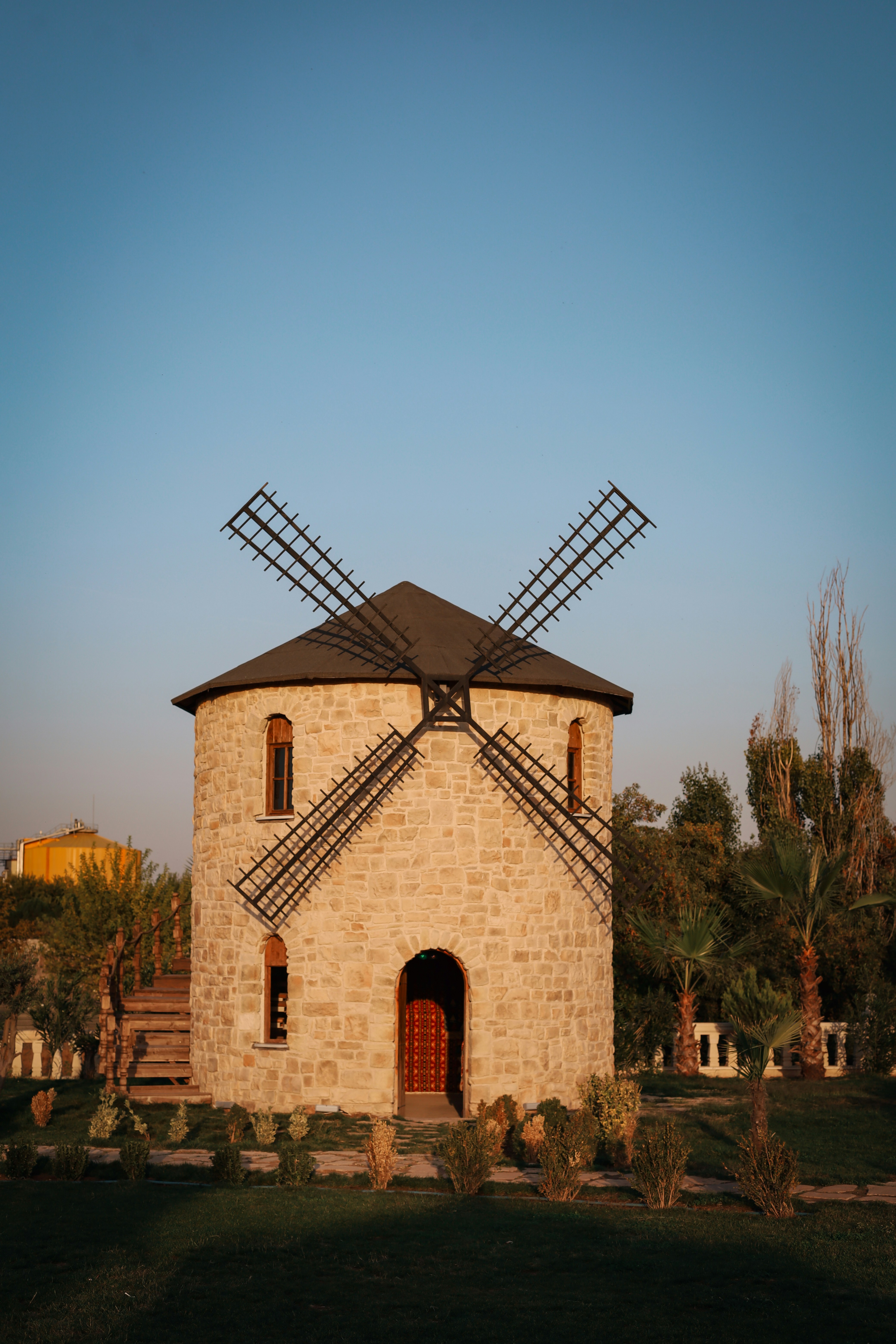 A building with a windmill on top of it photo – Free Blue Image on Unsplash