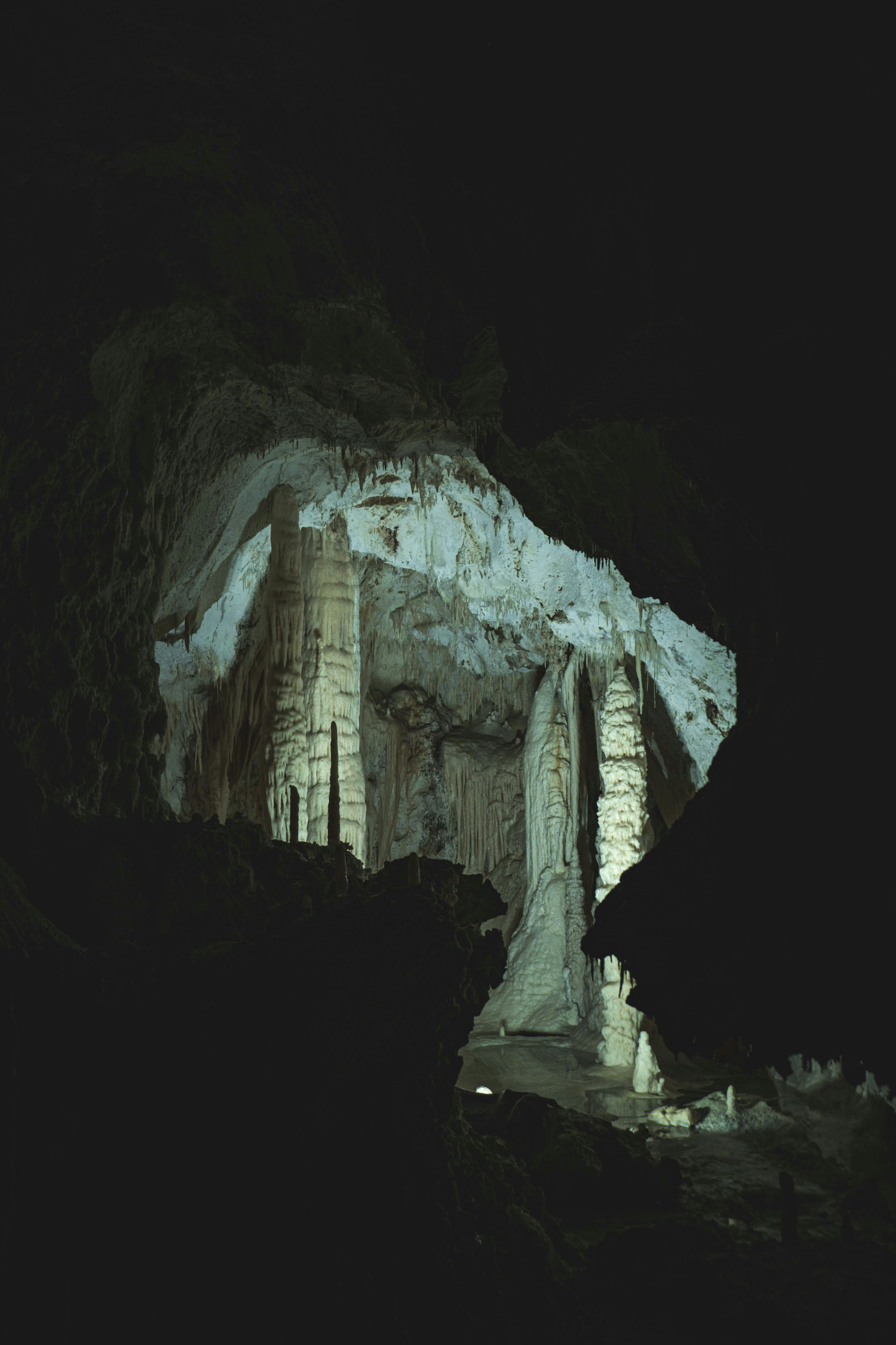 A cave filled with lots of cave like structures photo – Free Grey Image ...