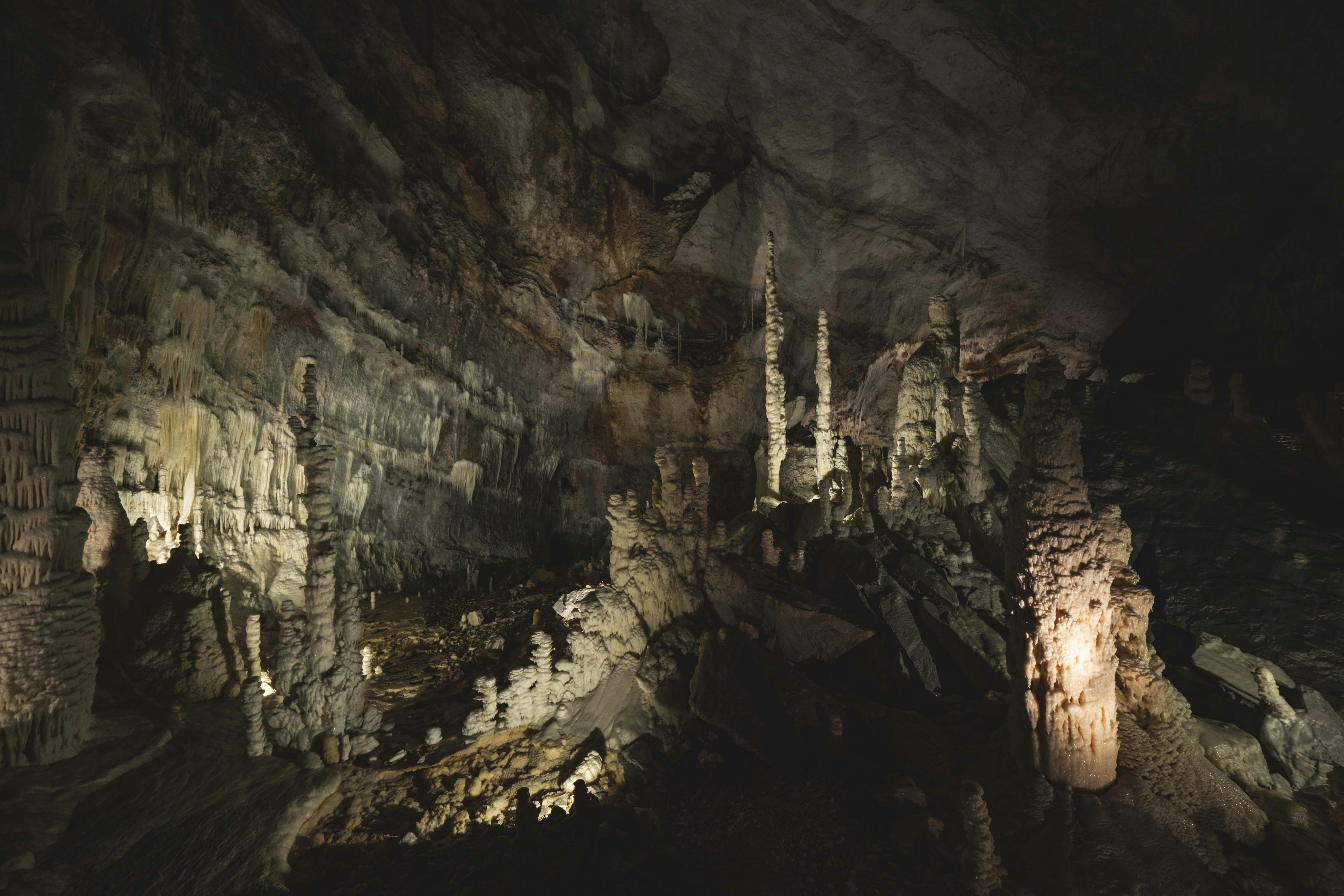 A cave filled with lots of cave like structures photo – Free Grey Image ...