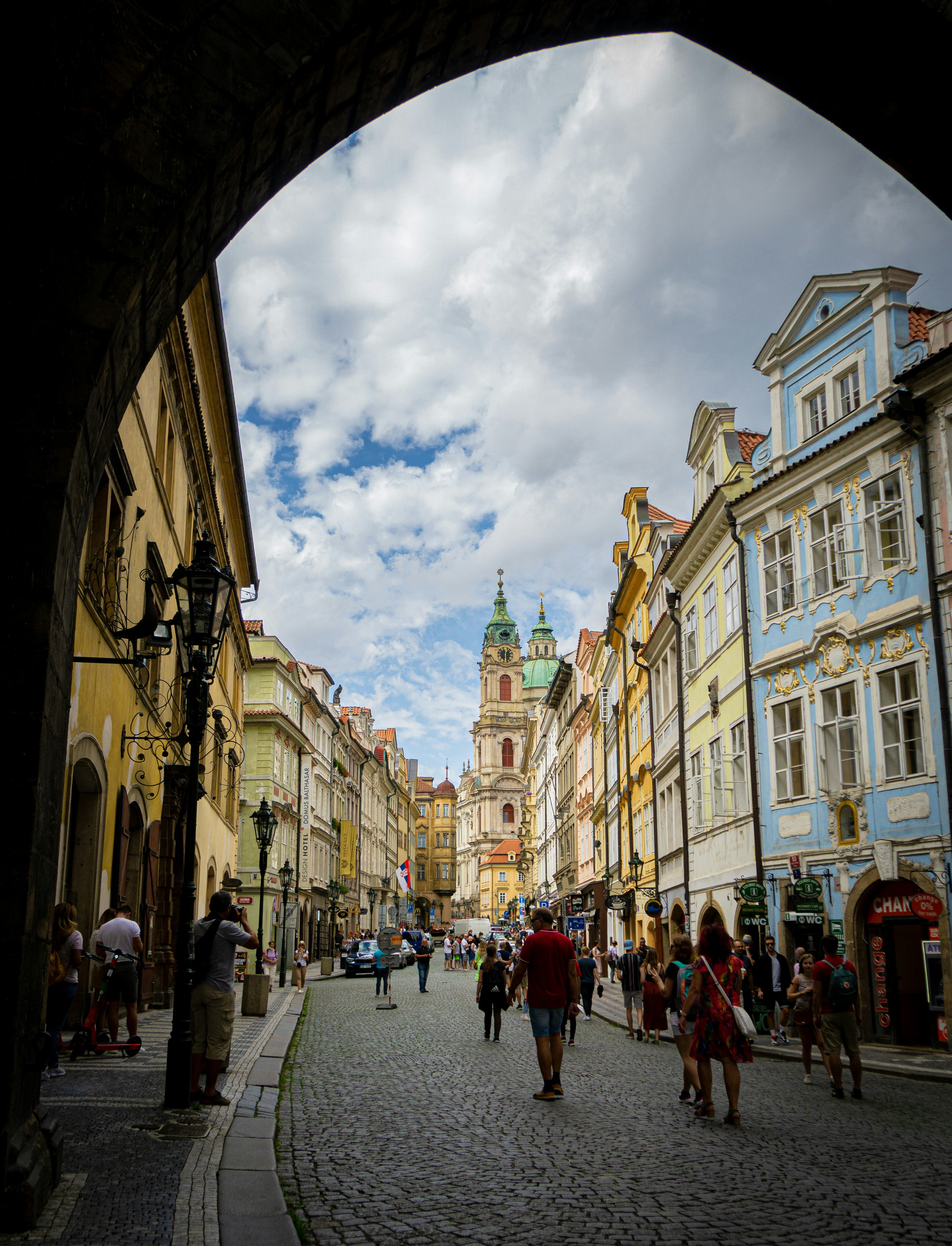 Archway Convergence: A Cobblestone Corridor Toward the Baroque Cathedral