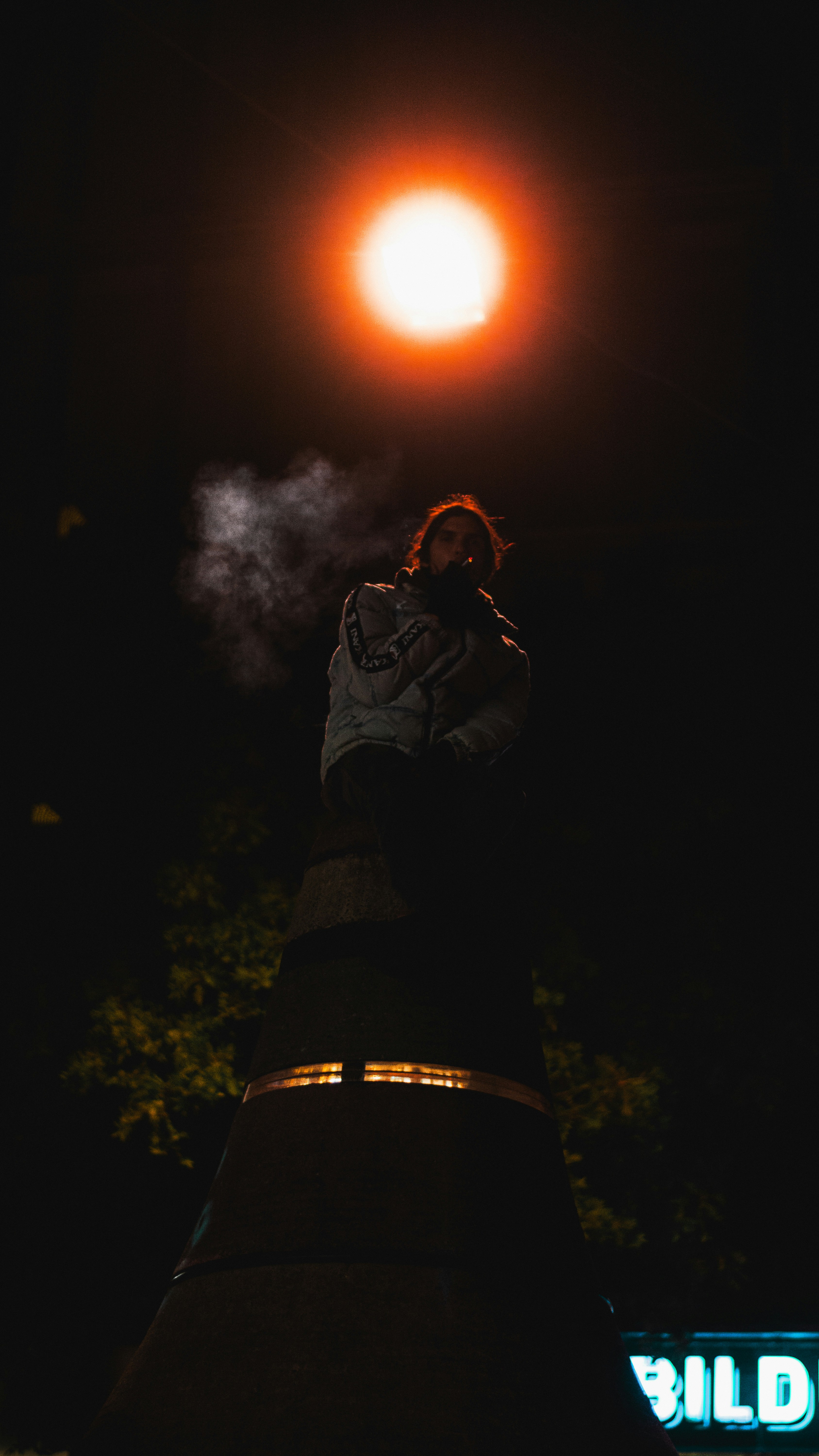 Ember Lantern Overhead: A Night Silhouette on the Monument
