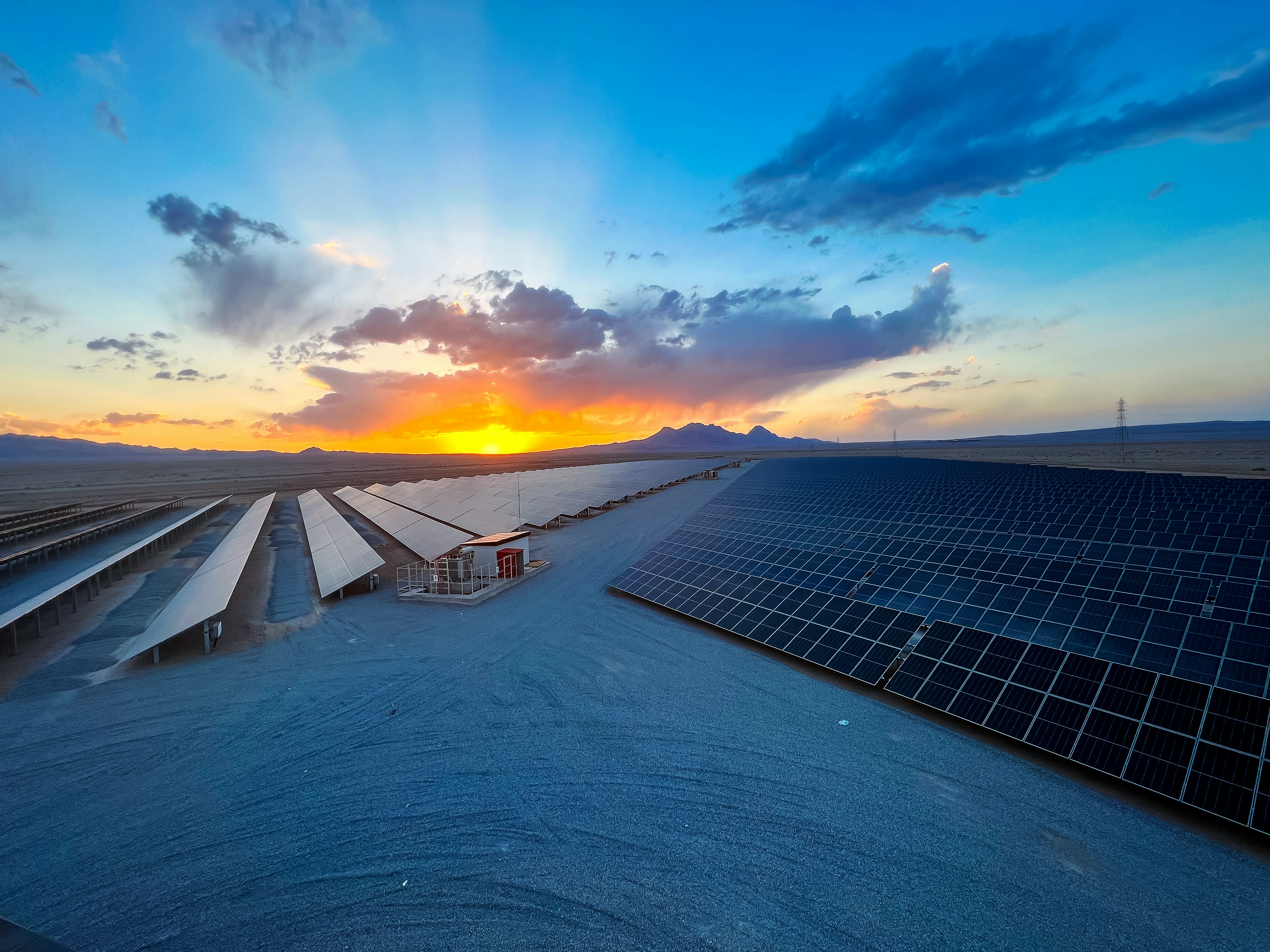 The sun is setting over the roof of a building photo – Free 10mw solar ...