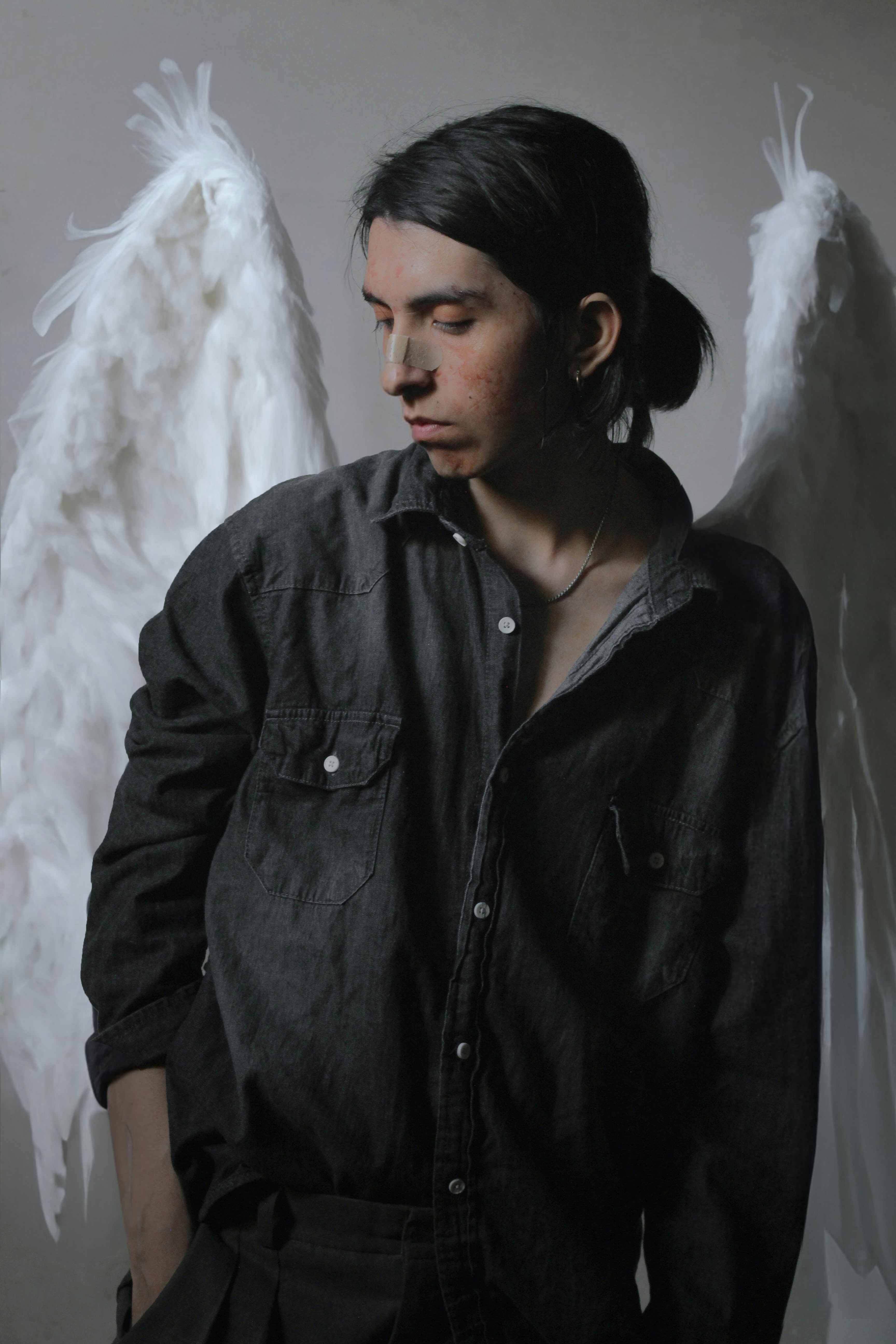 Feathered Echoes: A contemplative studio portrait with angel wings