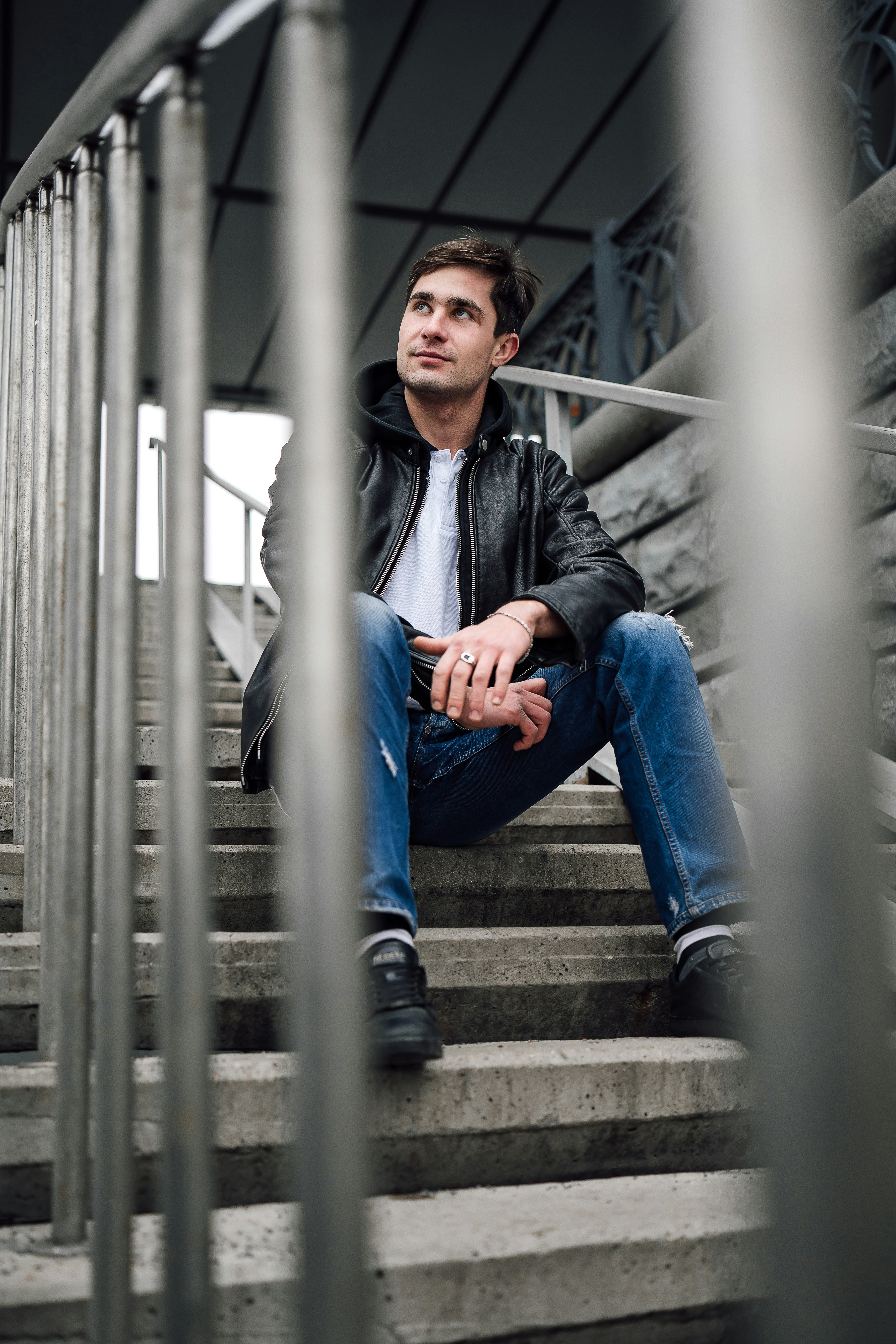 A man sitting on the steps of a building photo – Free Набережная тараса ...