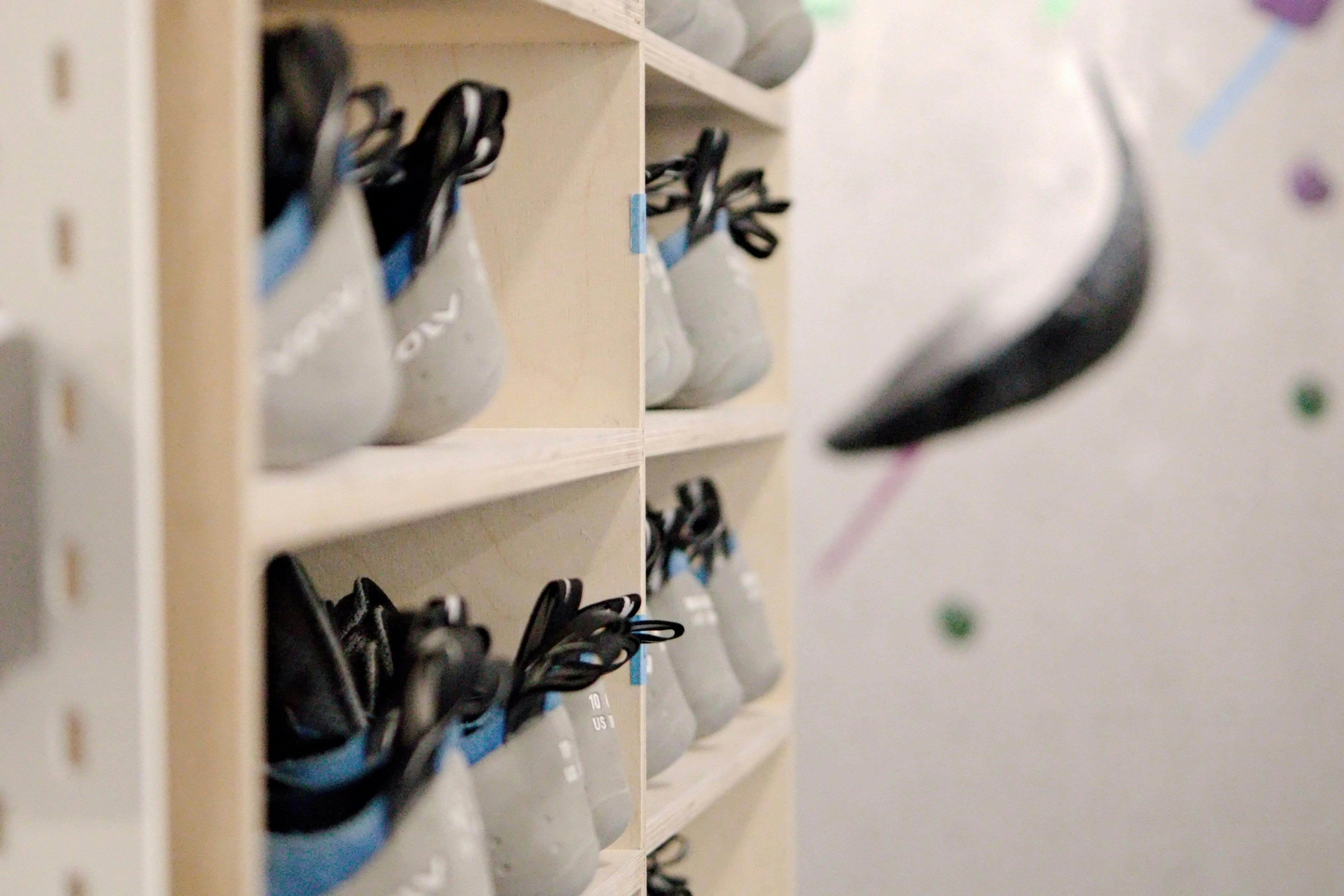 Row by Row: Climbing Shoes in a Wooden Cubby, Ready for the Next Ascent