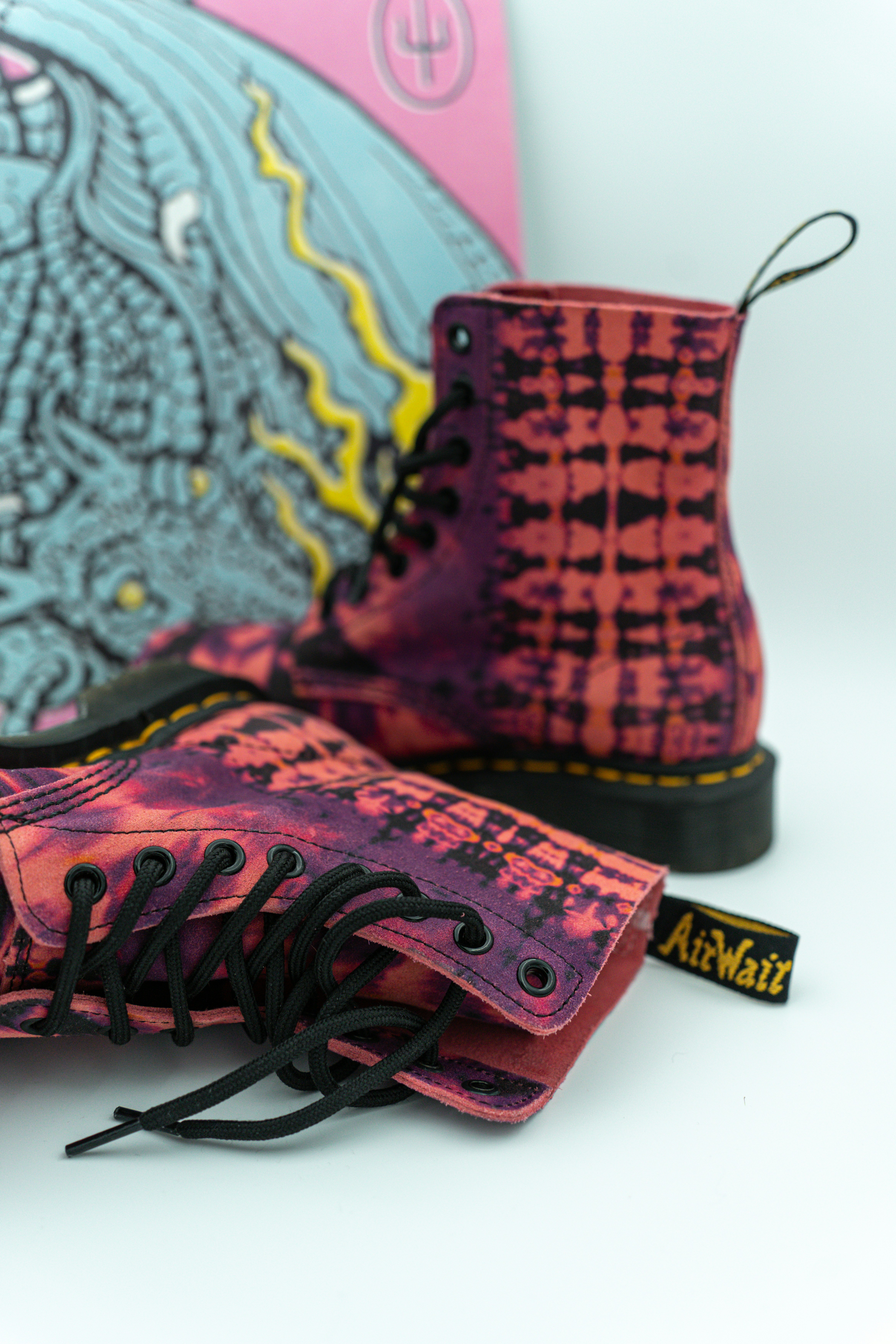 A pair of colorful boots sitting on top of a table photo – Free Shoe ...