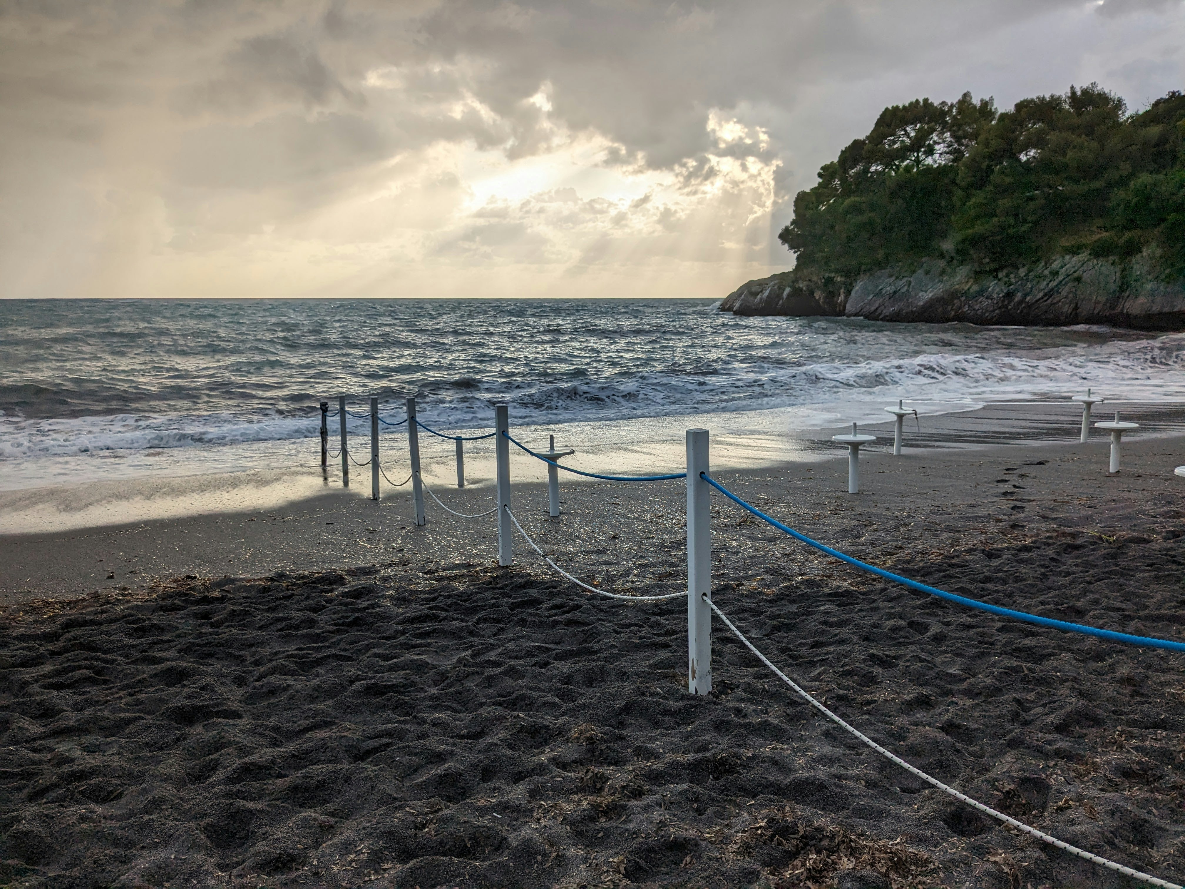 A beach with a roped off area next to the ocean photo – Free Nature ...