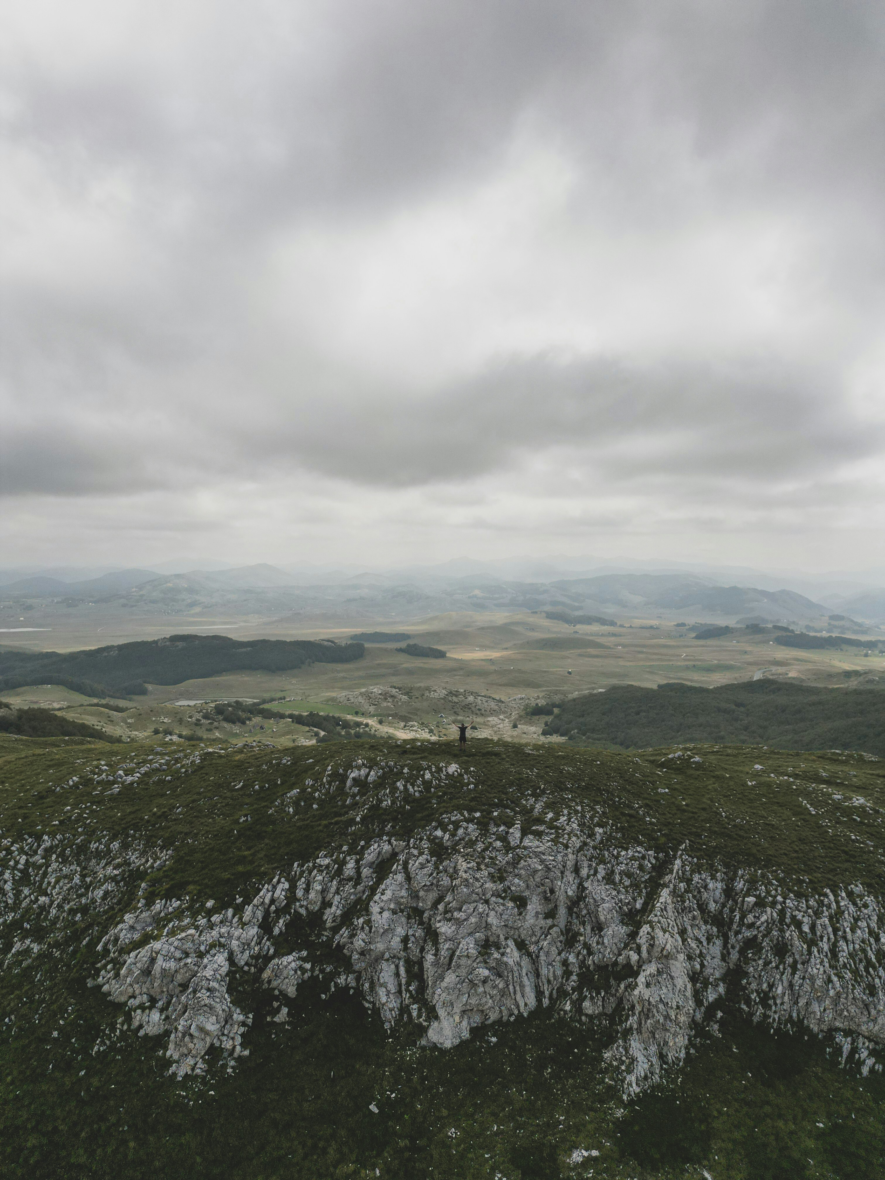 Lone Sentinel on a Granite Ridge Beneath Grey Skies