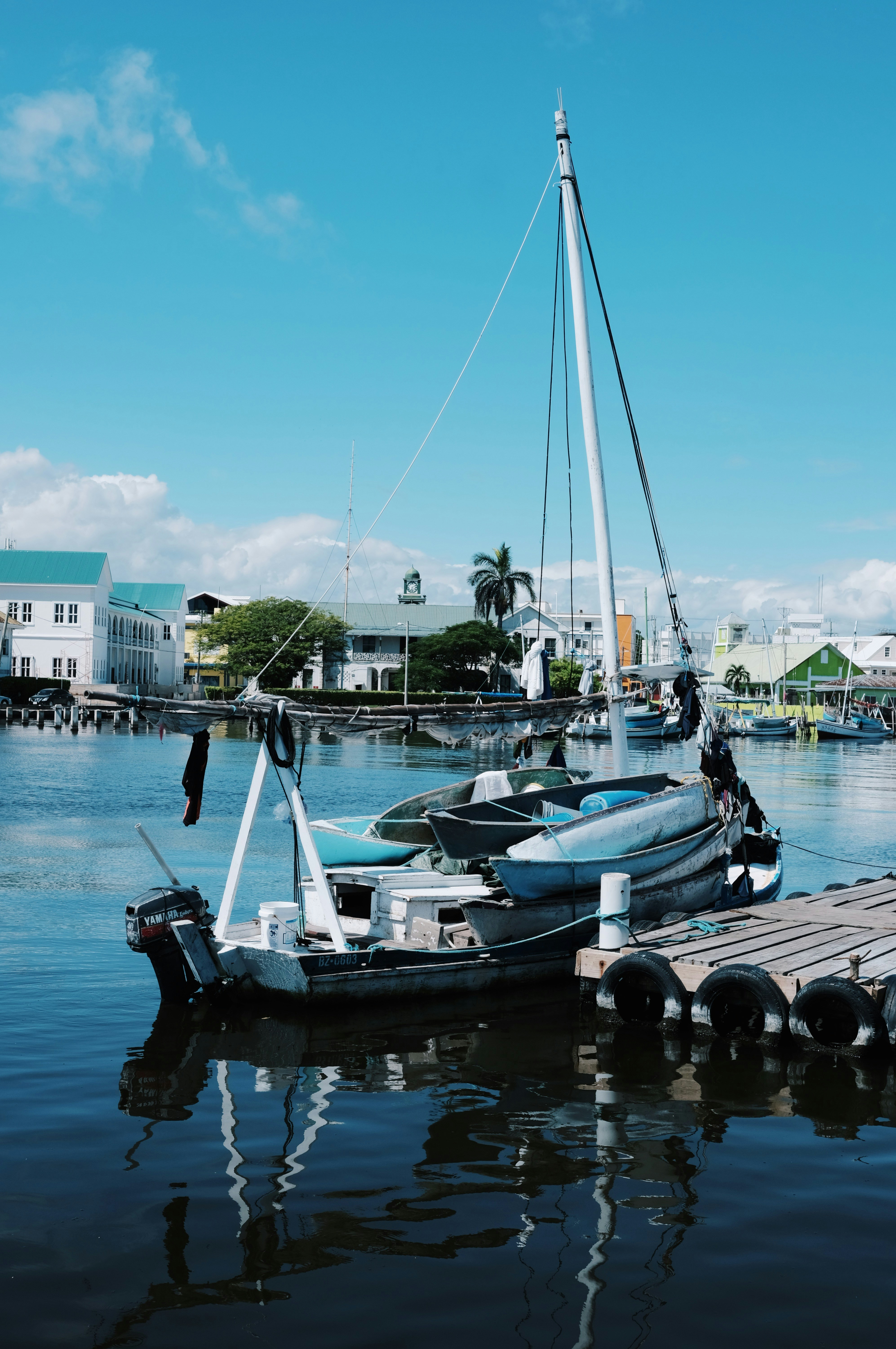 A boat is docked at a dock in the water photo – Free Belize Image on ...