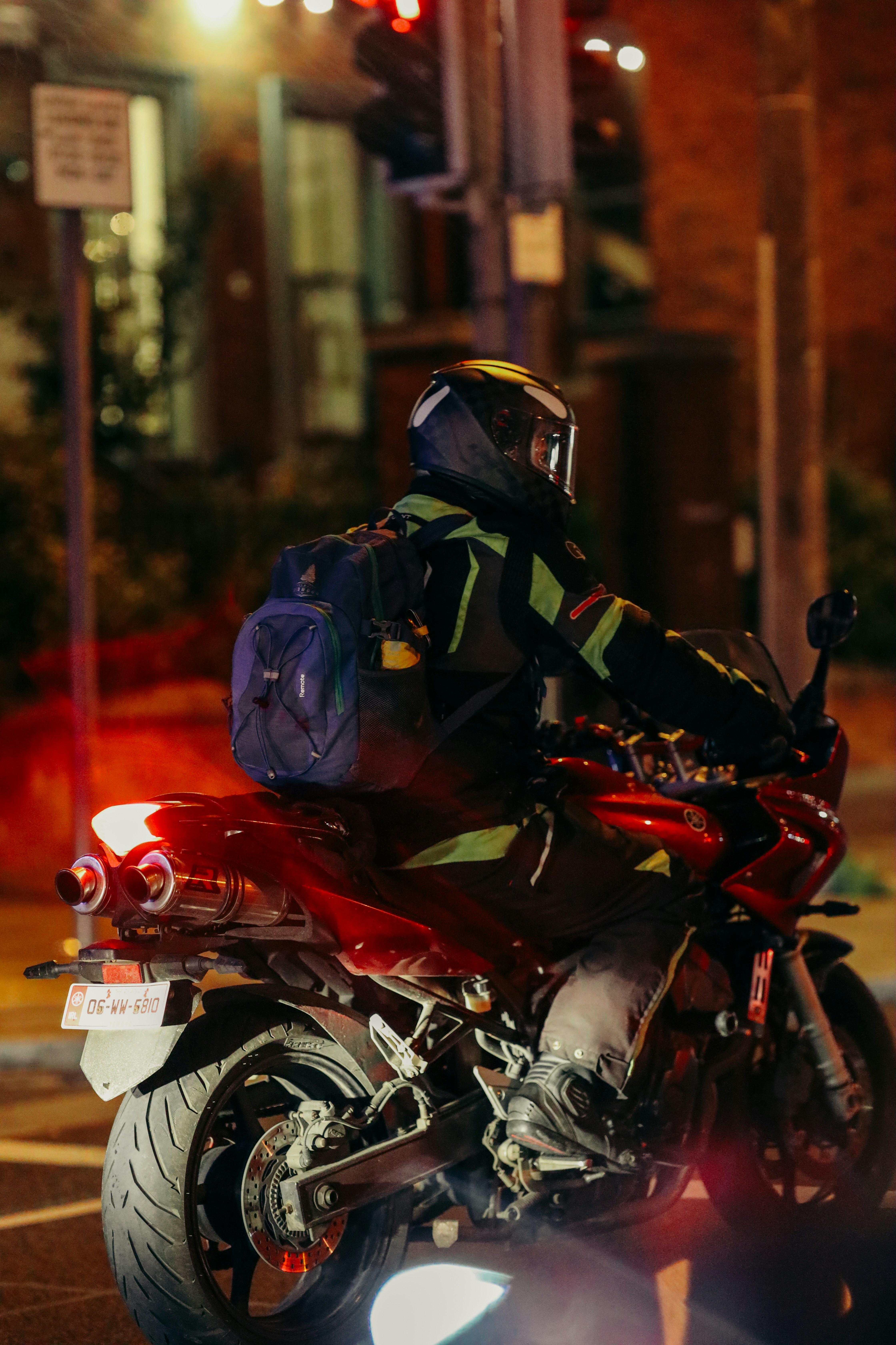 Crimson Night Run: Neon-Trim Rider on a Red Sportbike Under Streetlights