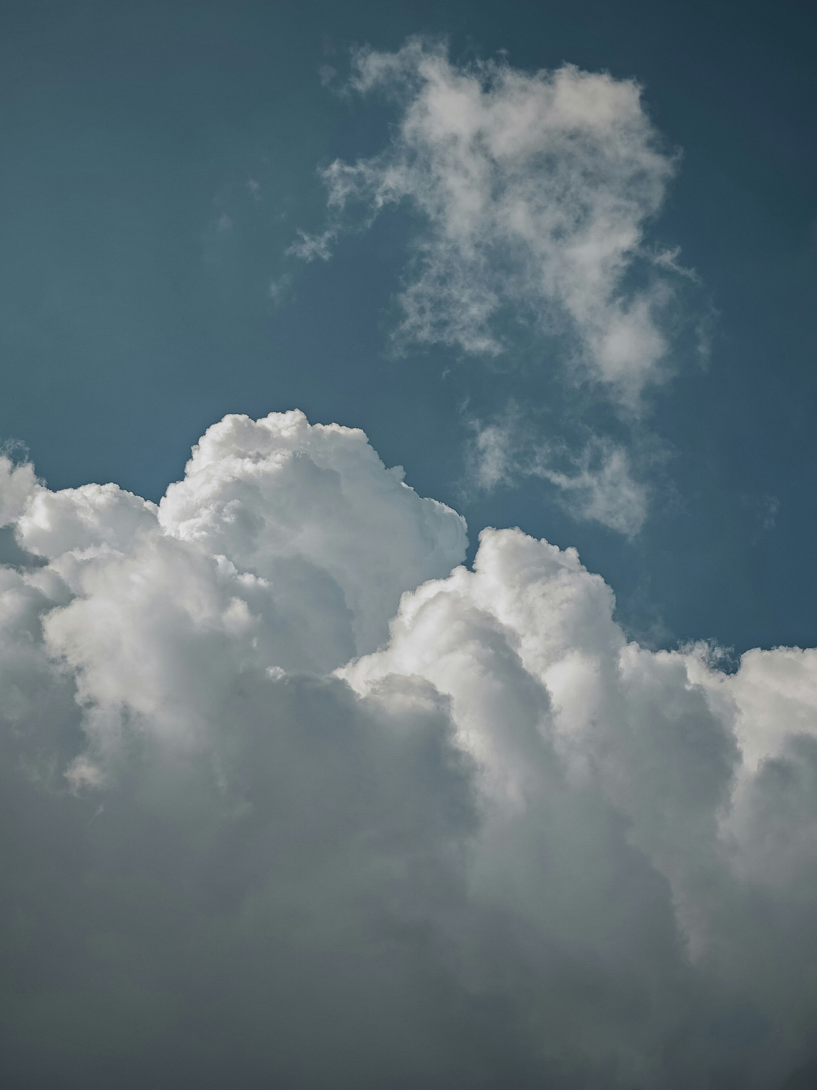 A plane flying through a cloudy blue sky photo – Free Grey Image on ...