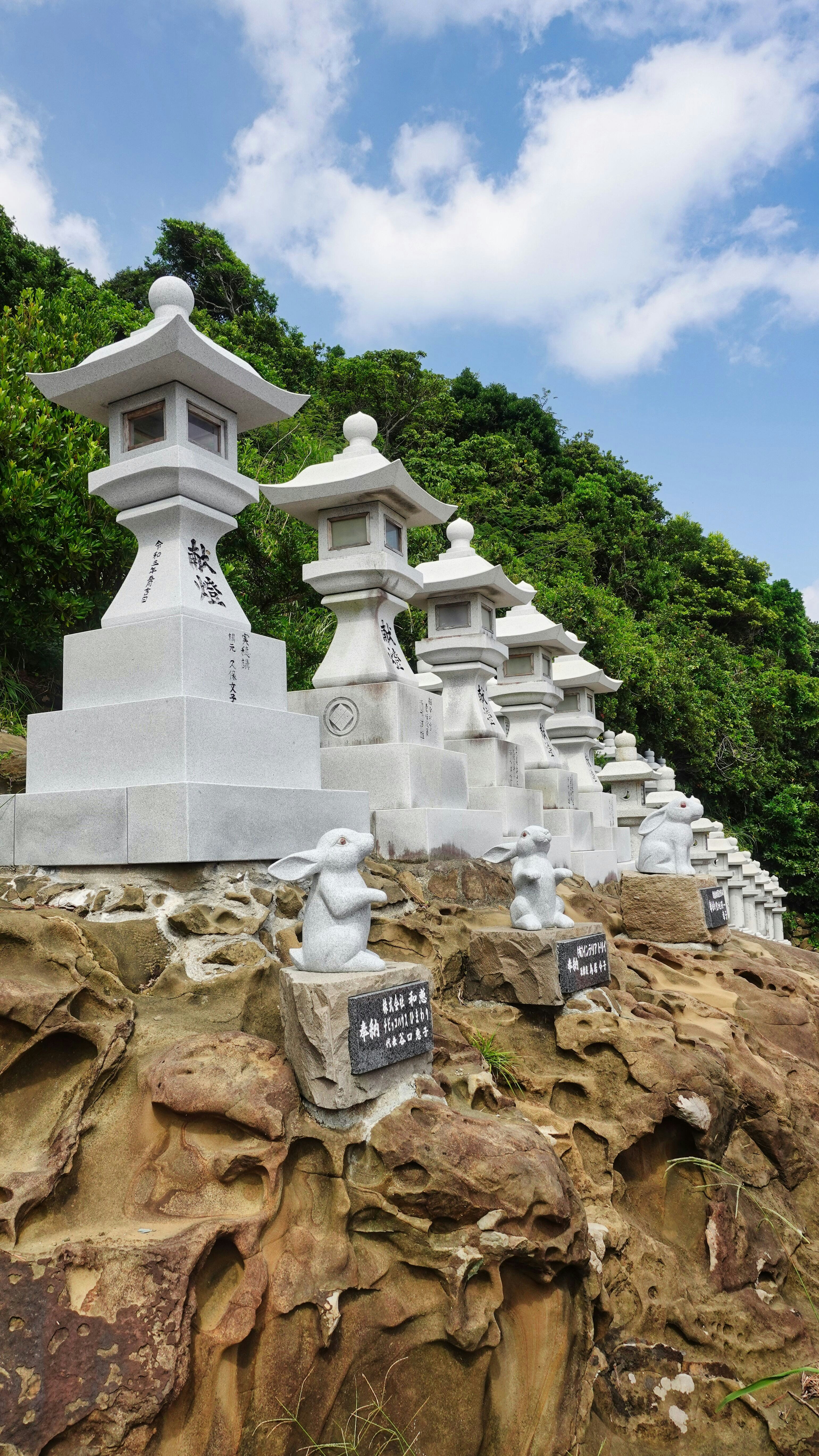 Lantern Line along a Rocky Ledge Under a Bright Blue Sky