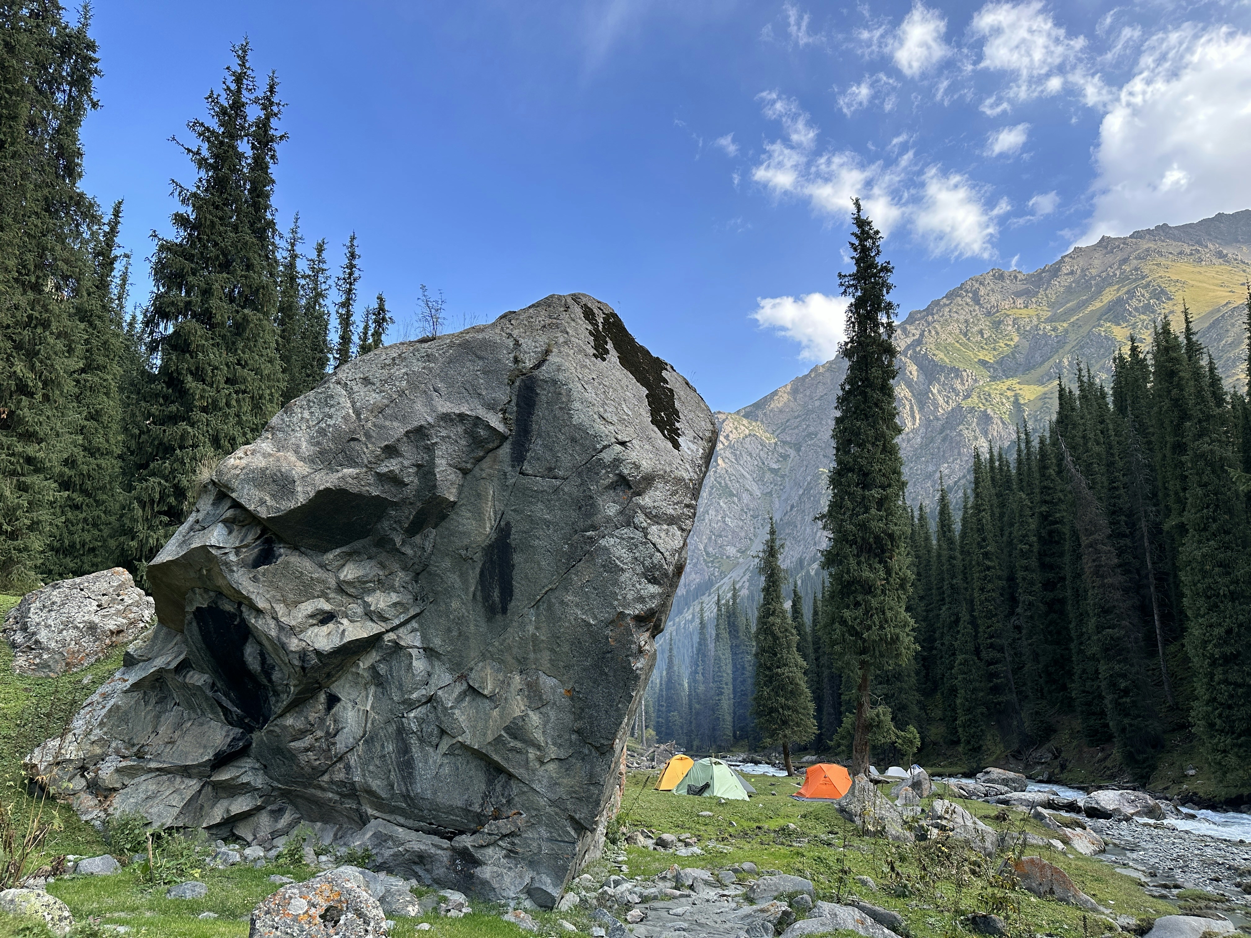 Colossal boulder sentinel watching over a mountain campsite