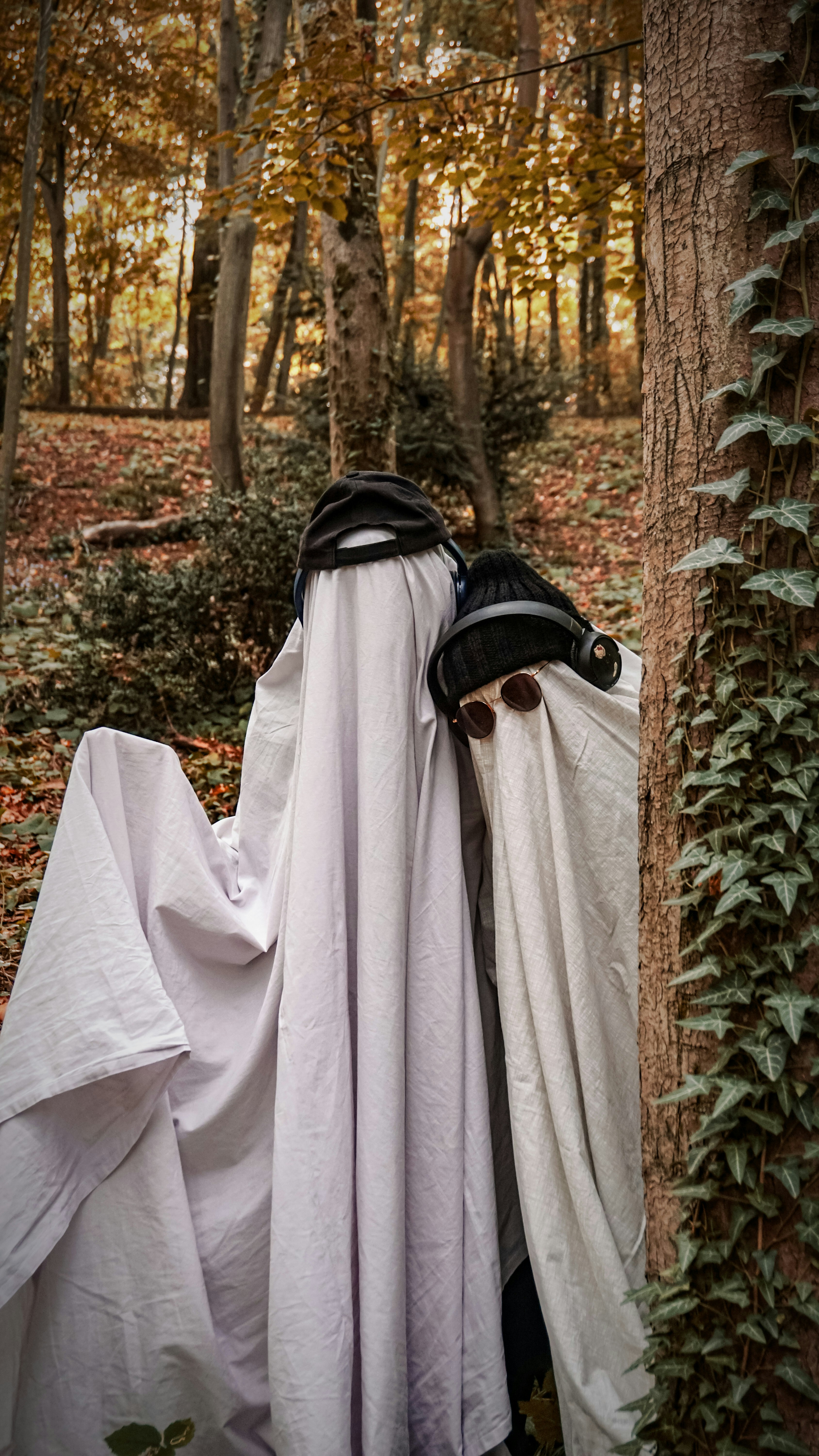 A person in a white cloak hiding behind a tree photo – Free Fashion ...
