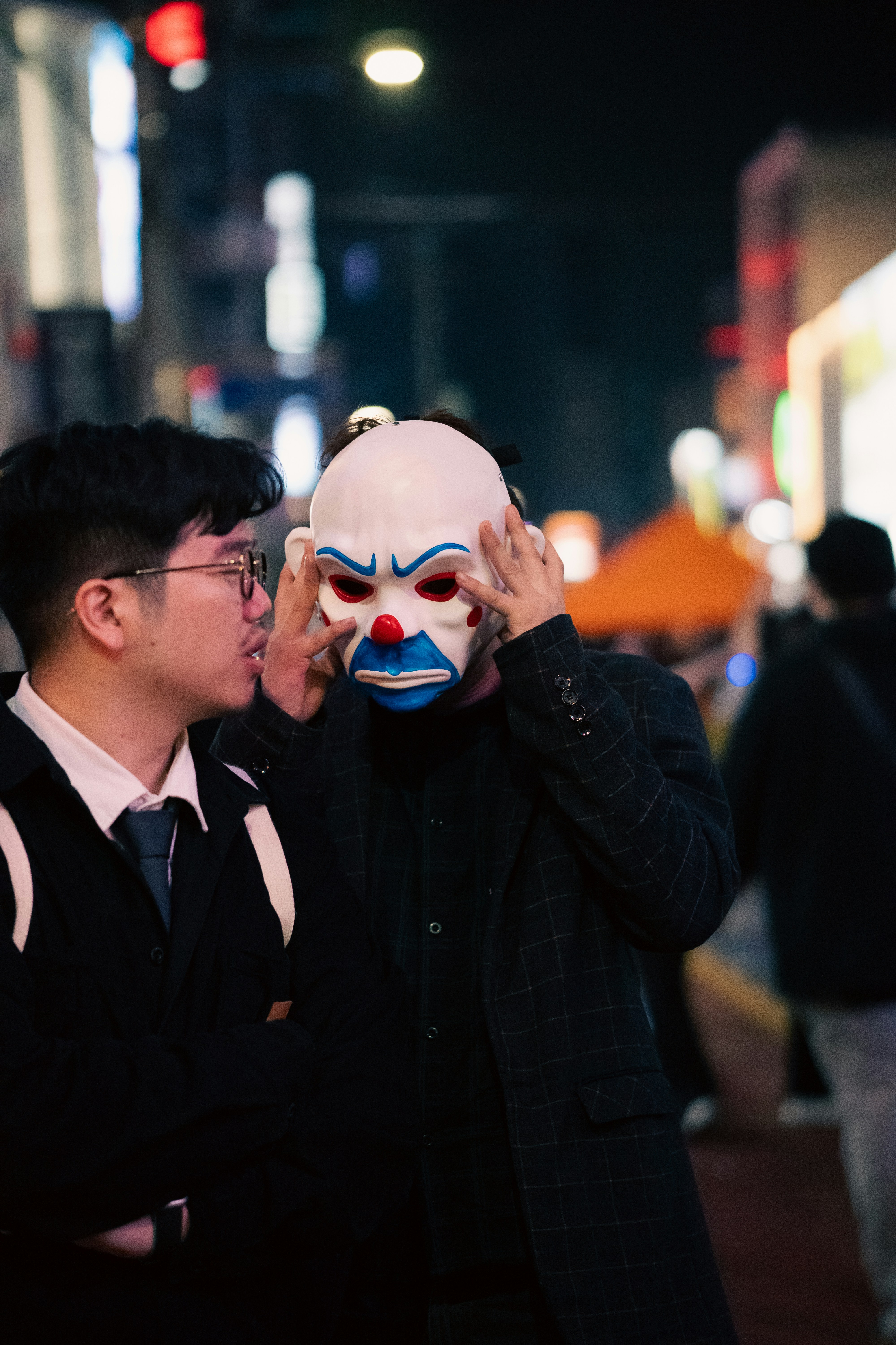A man in a suit kissing a clown mask photo – Free Halloween Image on ...