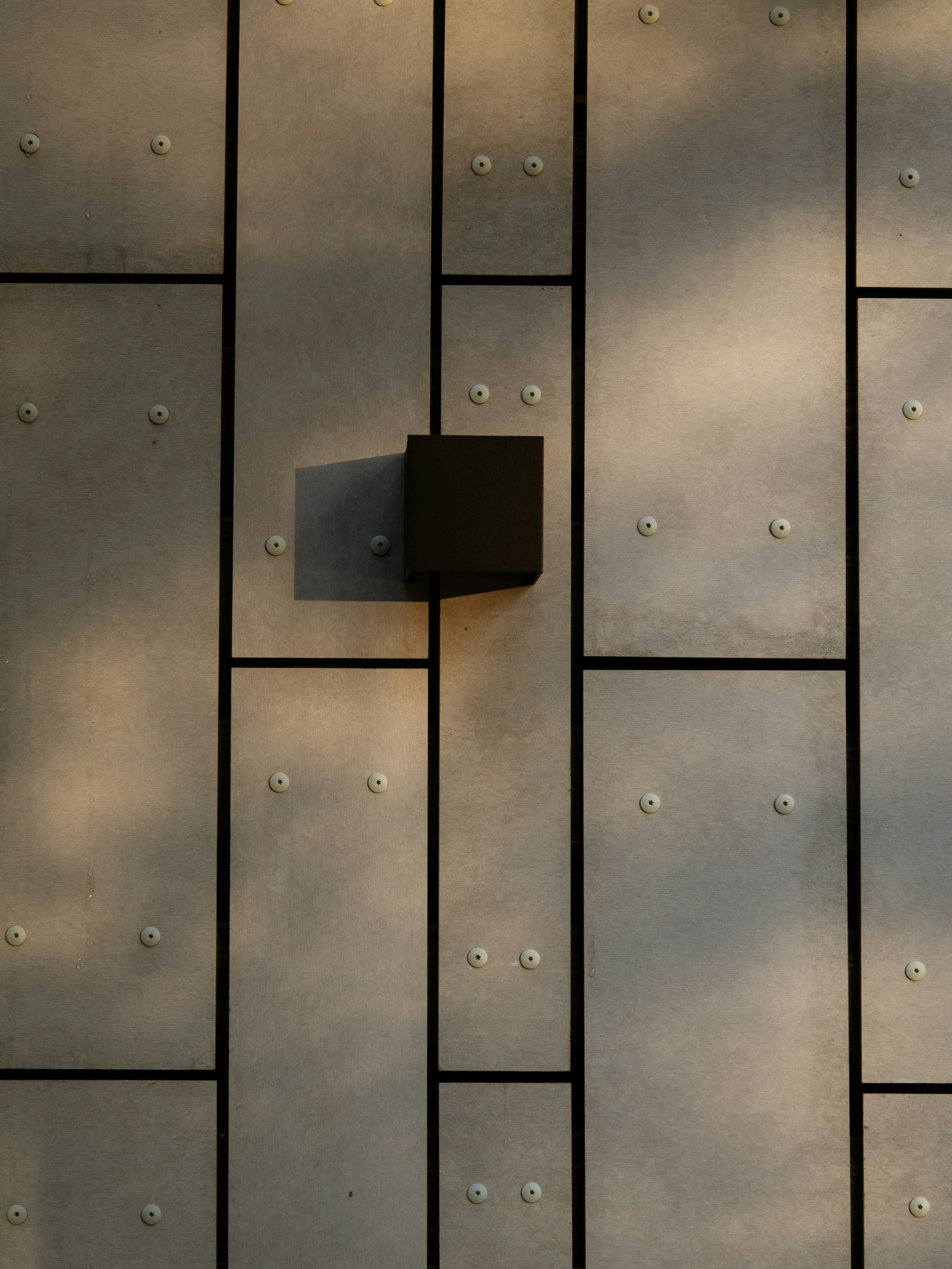 A square object is mounted to the side of a wall photo – Free House ...