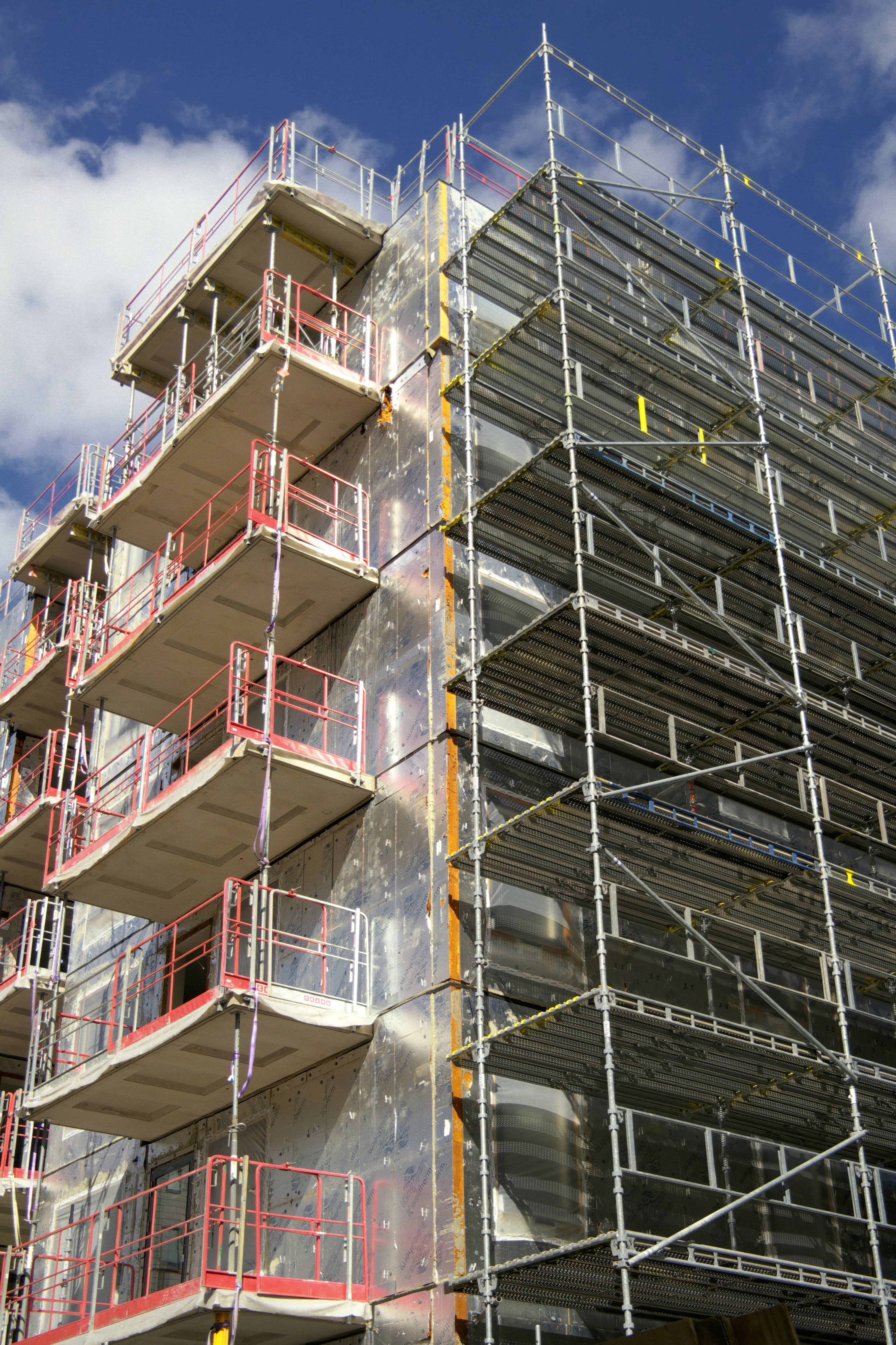 A very tall building with lots of scaffolding on it photo – Free Täby ...