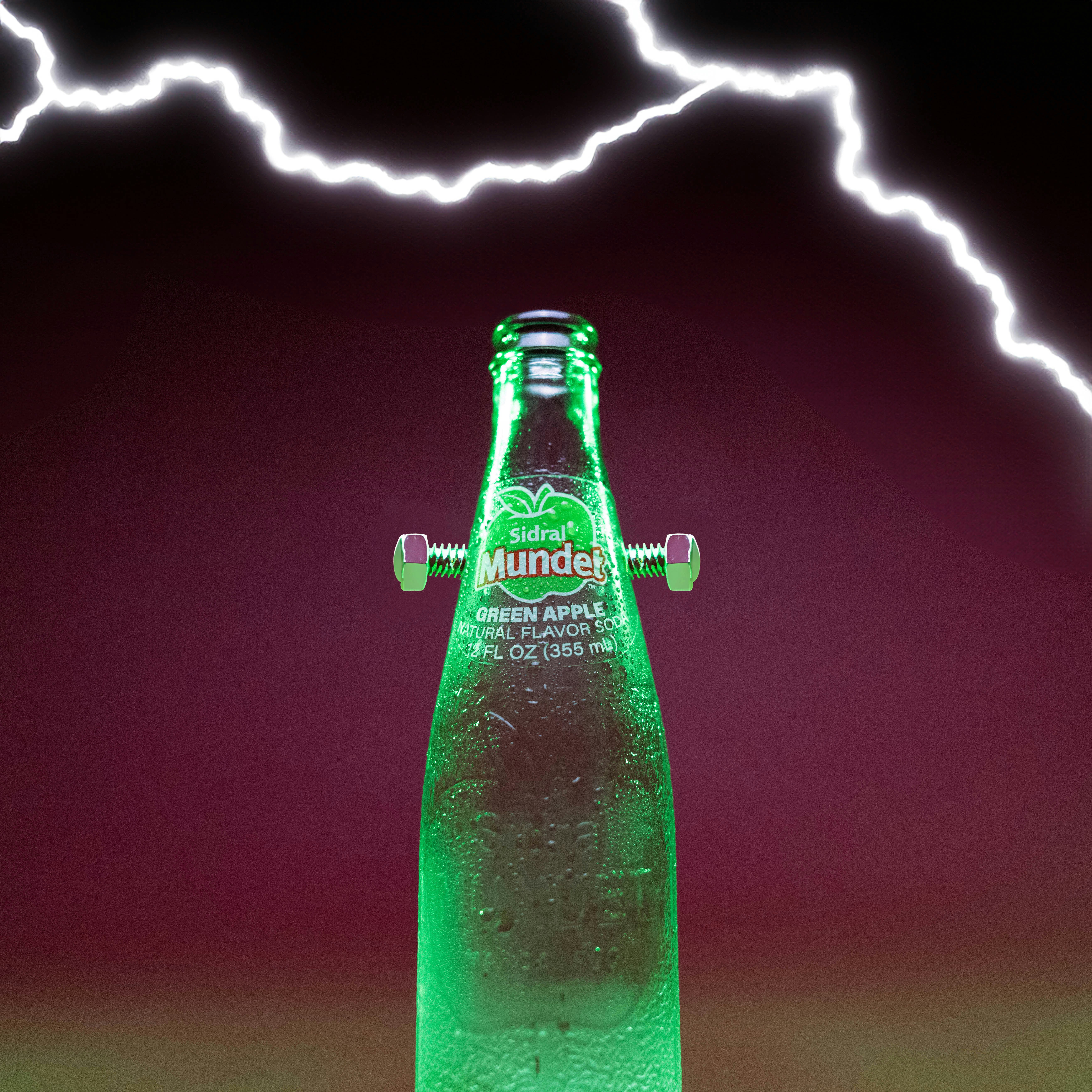 Electric Green: Sidral Mundet Bottle Under a Neon Storm
