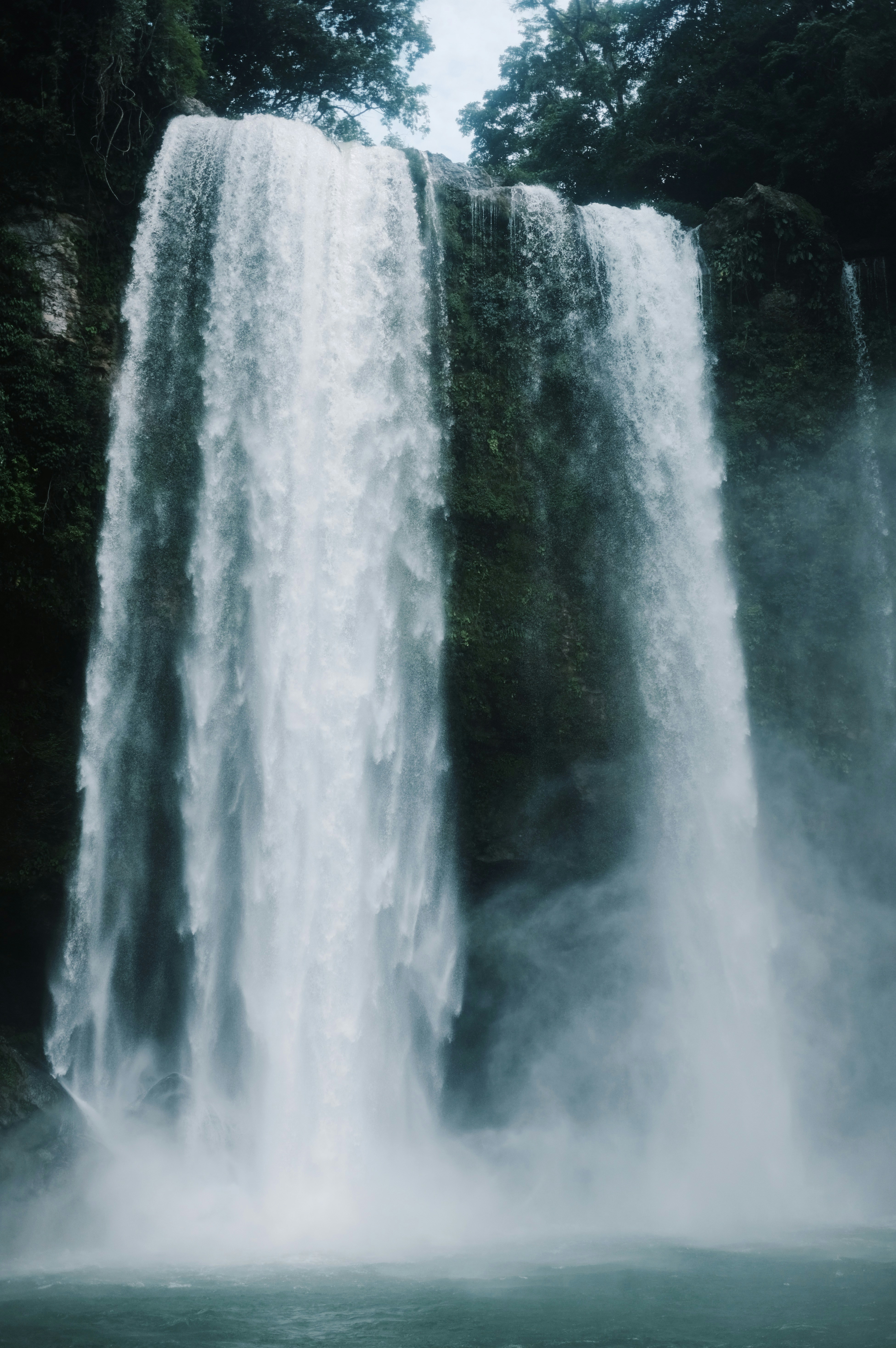 A large waterfall with water cascading over it photo – Free Grey Image ...
