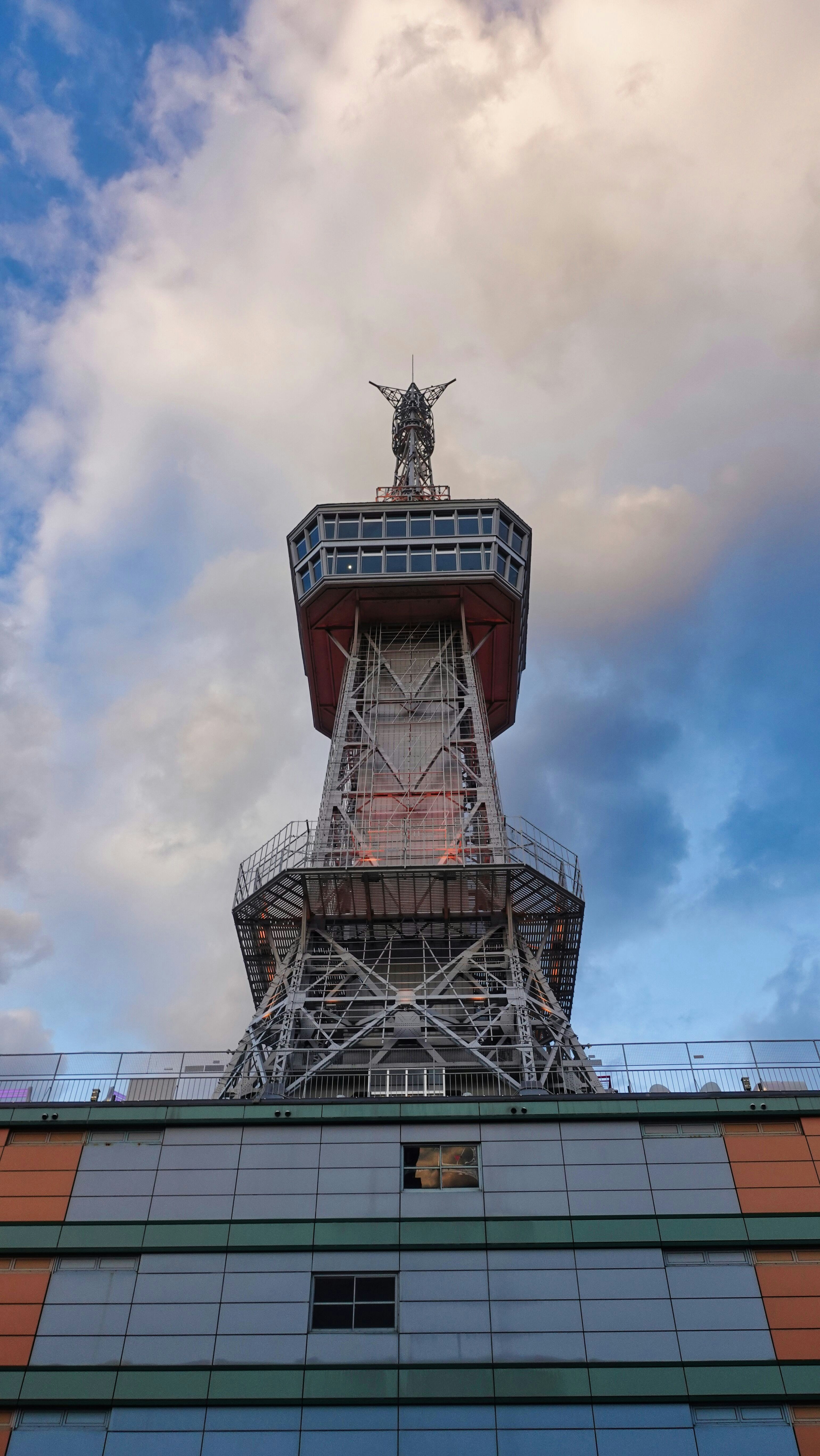 Lattice Tower Reaching the Sky Over a Colorblocked Base