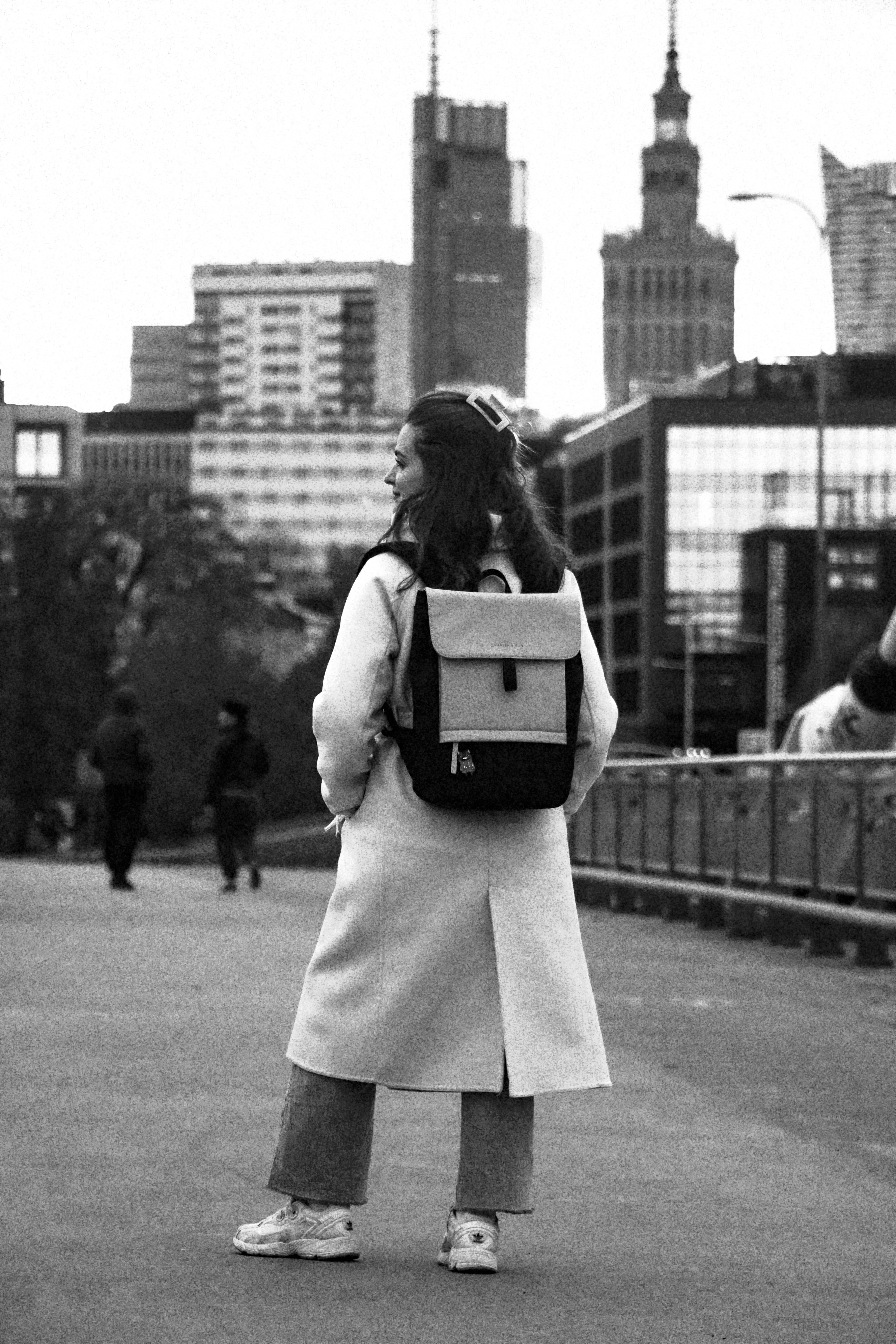 Urban Wanderer: Solo Portrait Against a Cityscape