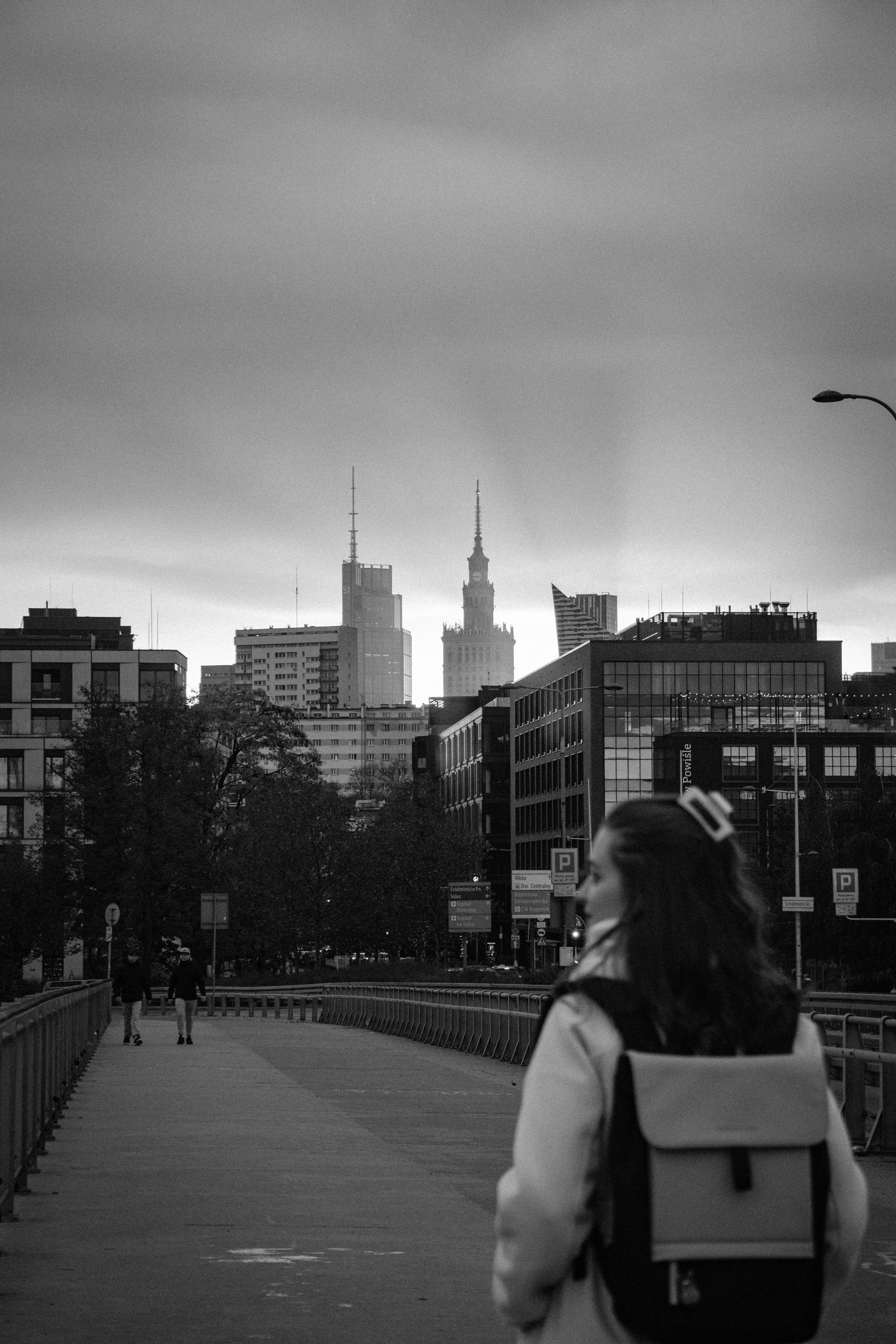 City silhouettes and a lone traveler: a grayscale urban vignette