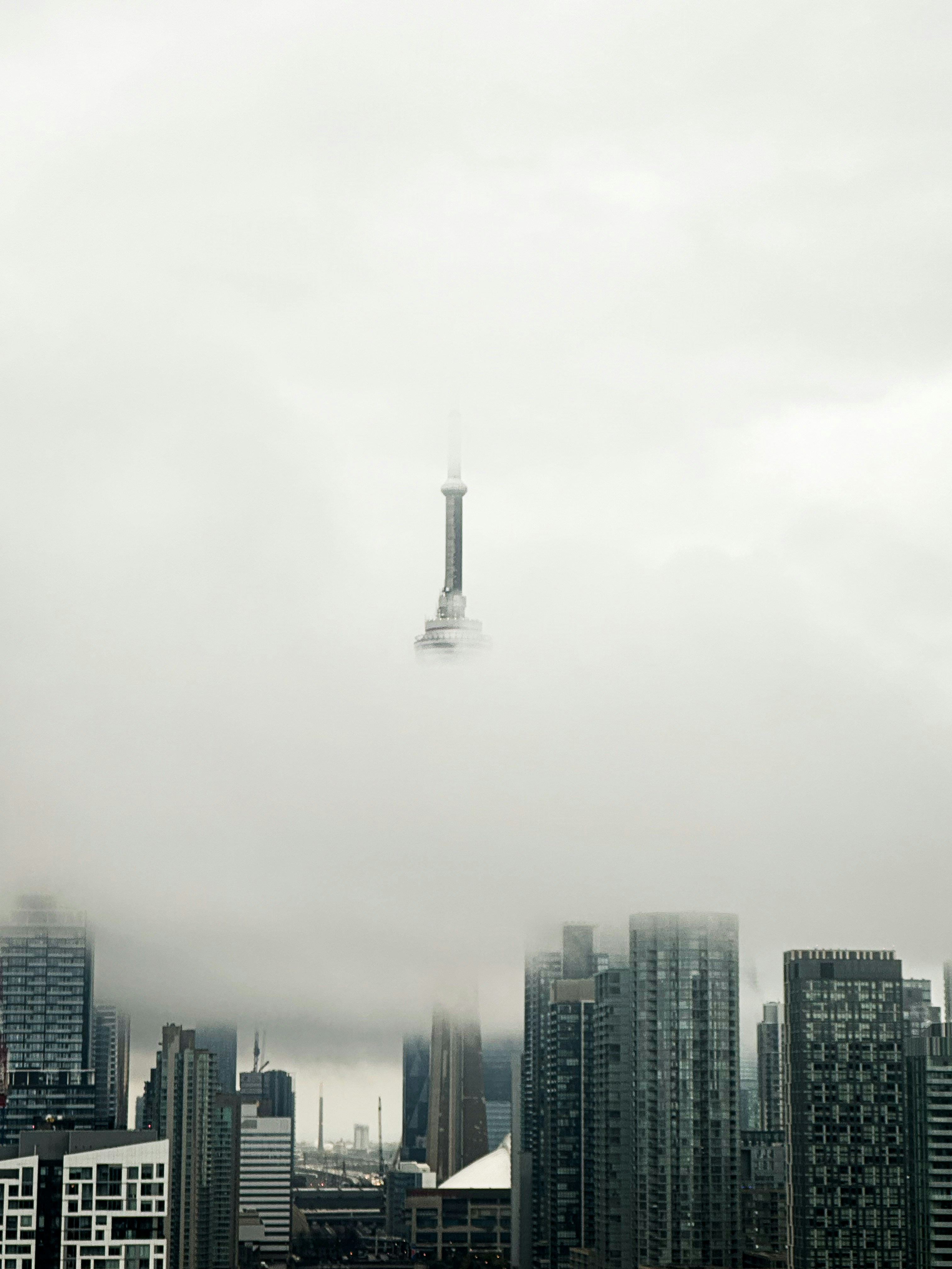 A very tall building towering over a city photo – Free Grey Image on ...