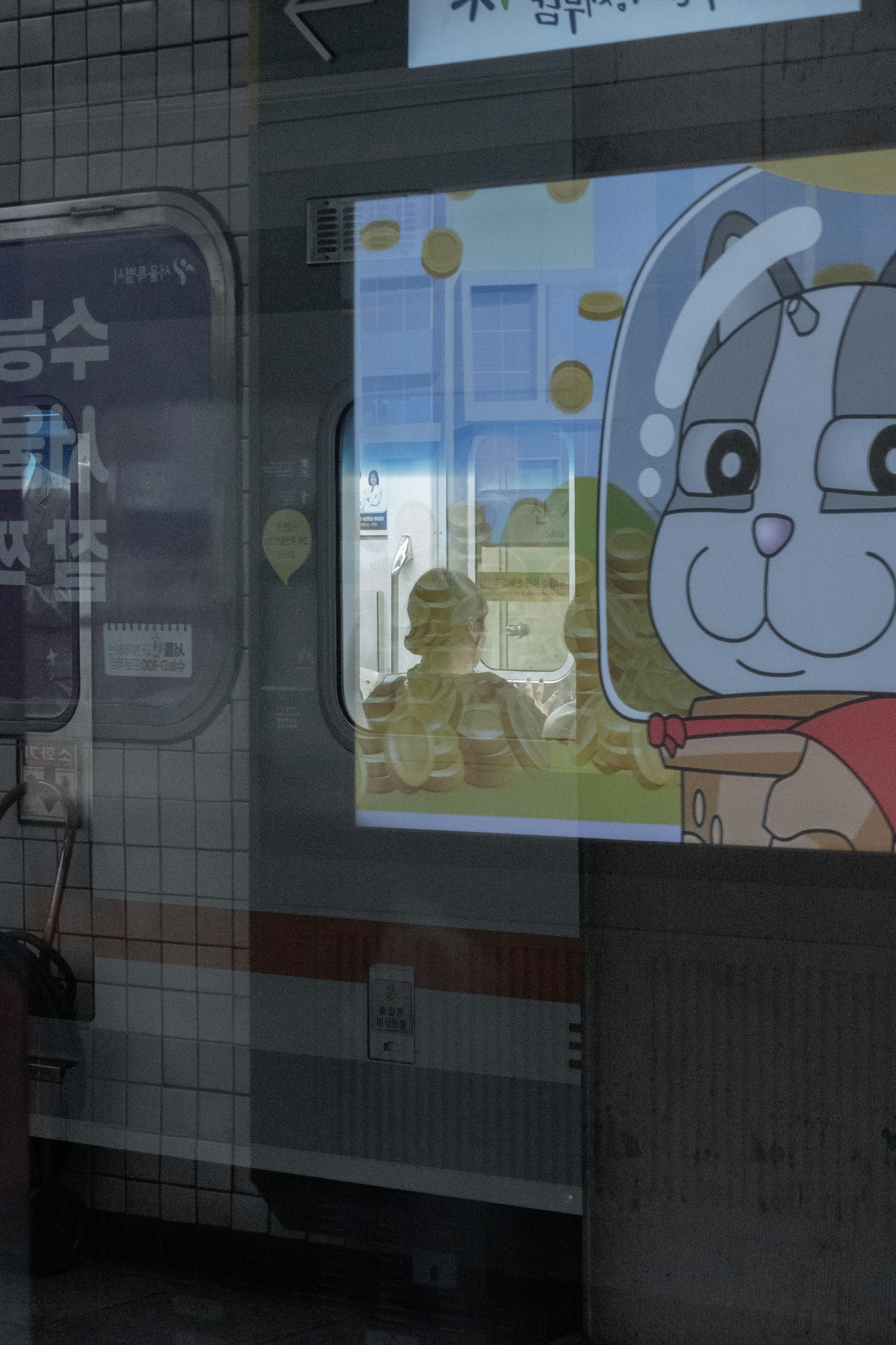 Glassbound Reflection: A Subway Scene Framed by a Cheery Bunny Advertisement
