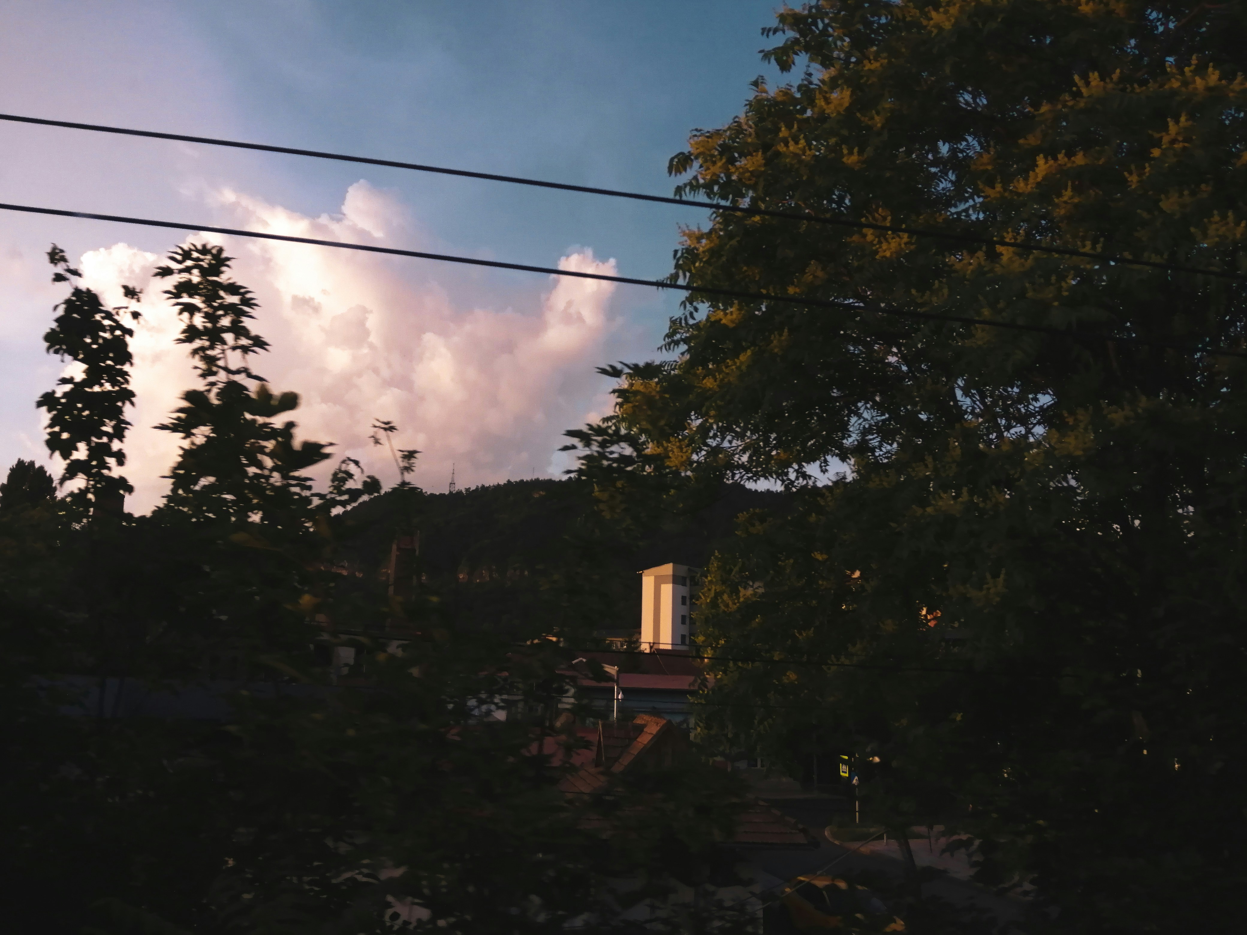 Dusk Between Wires: Cloud Light Over a Suburban Ridge