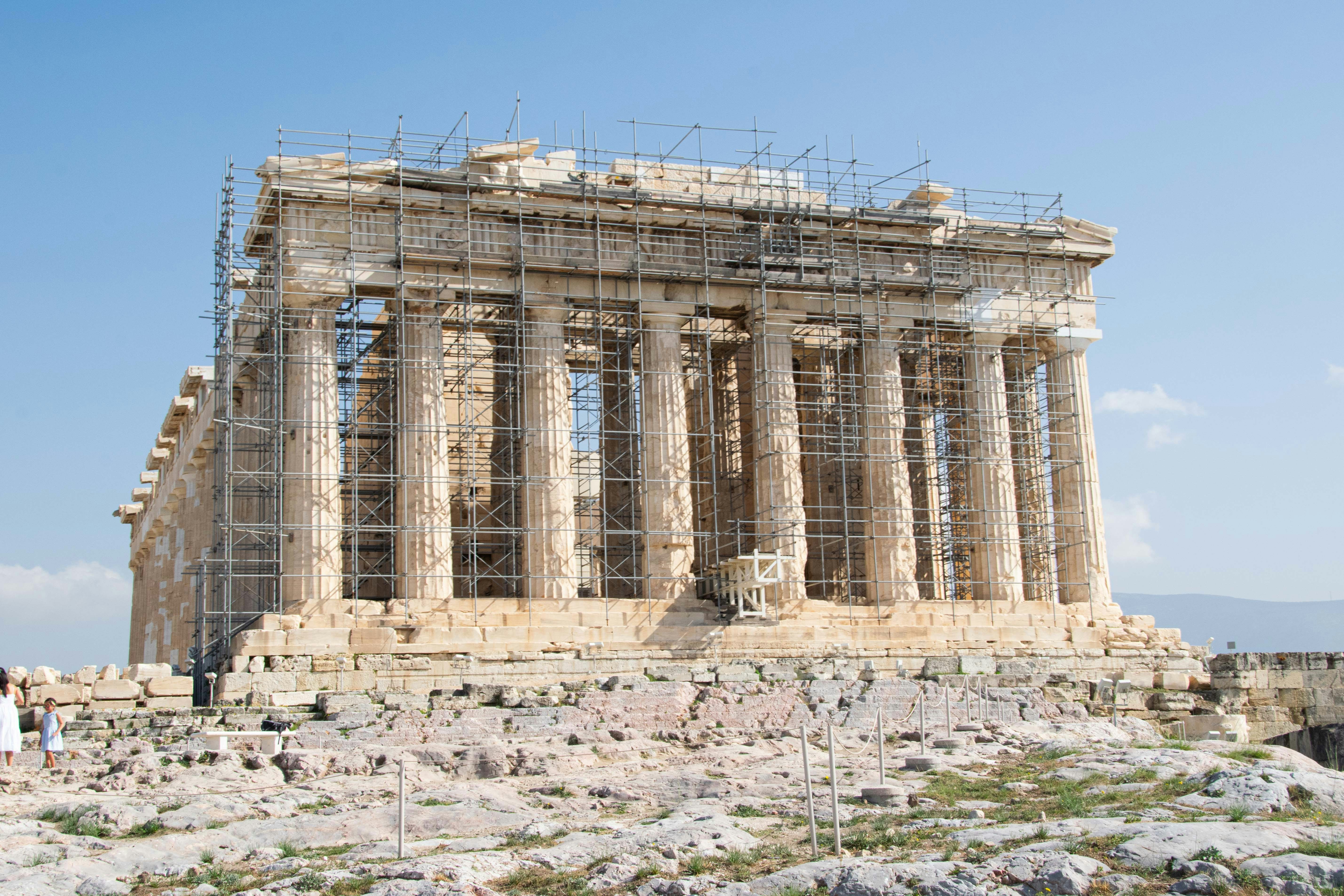 A large stone building with scaffolding around it photo – Free Building ...