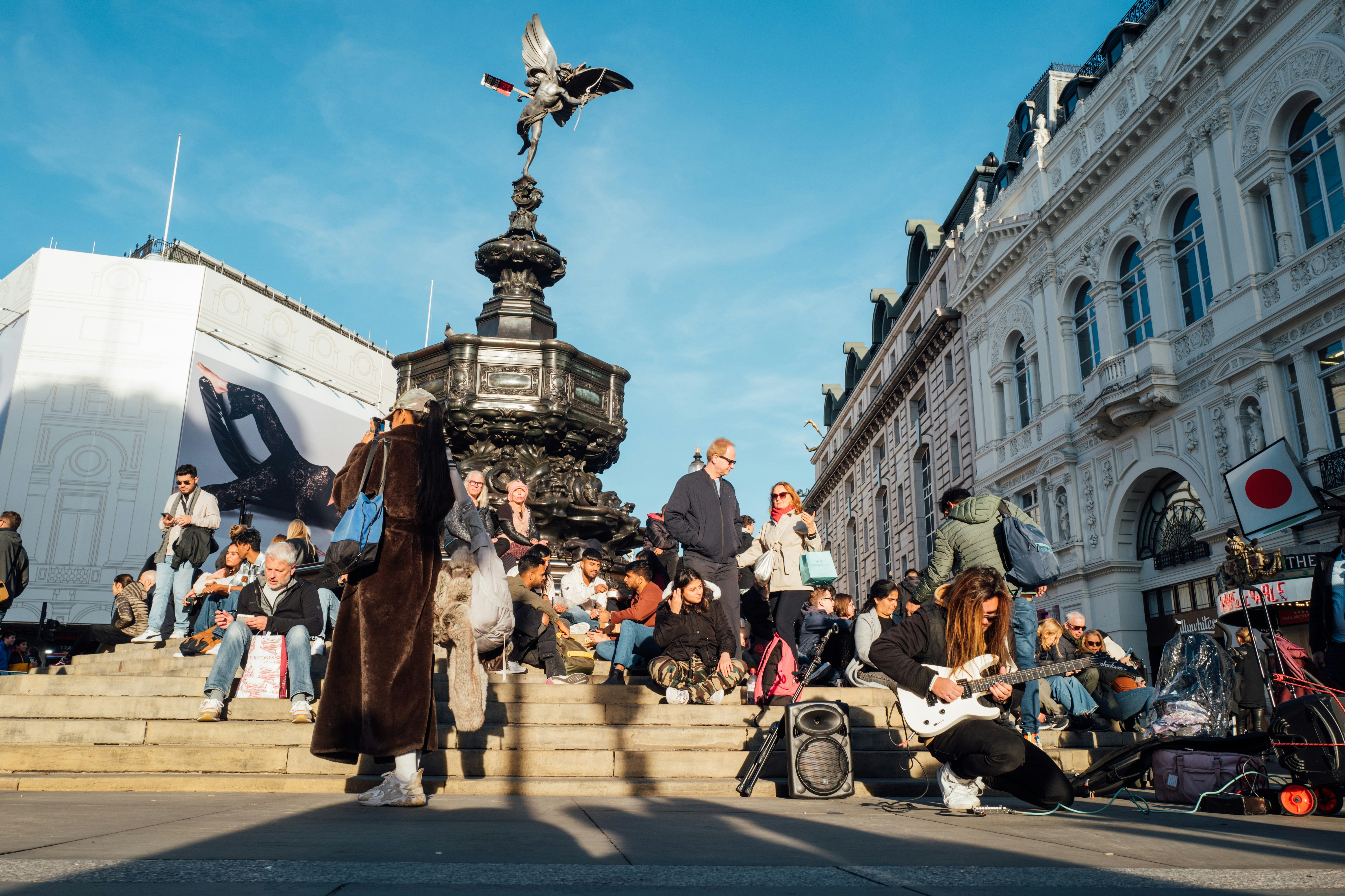 Sunlit Steps at the Fountain: Crowd and Monument in Motion
