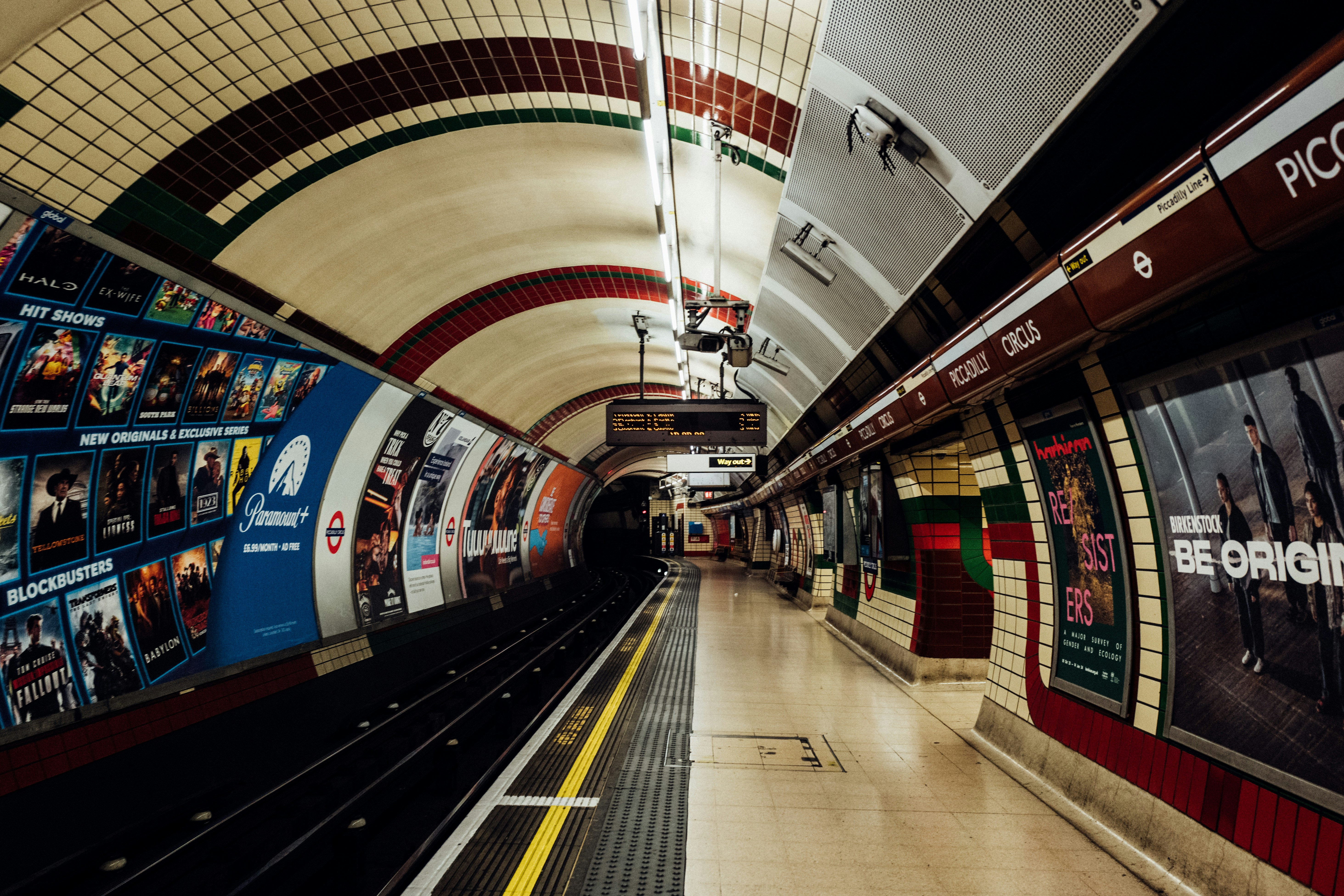 A subway station with a train pulling into it photo – Free London Image ...