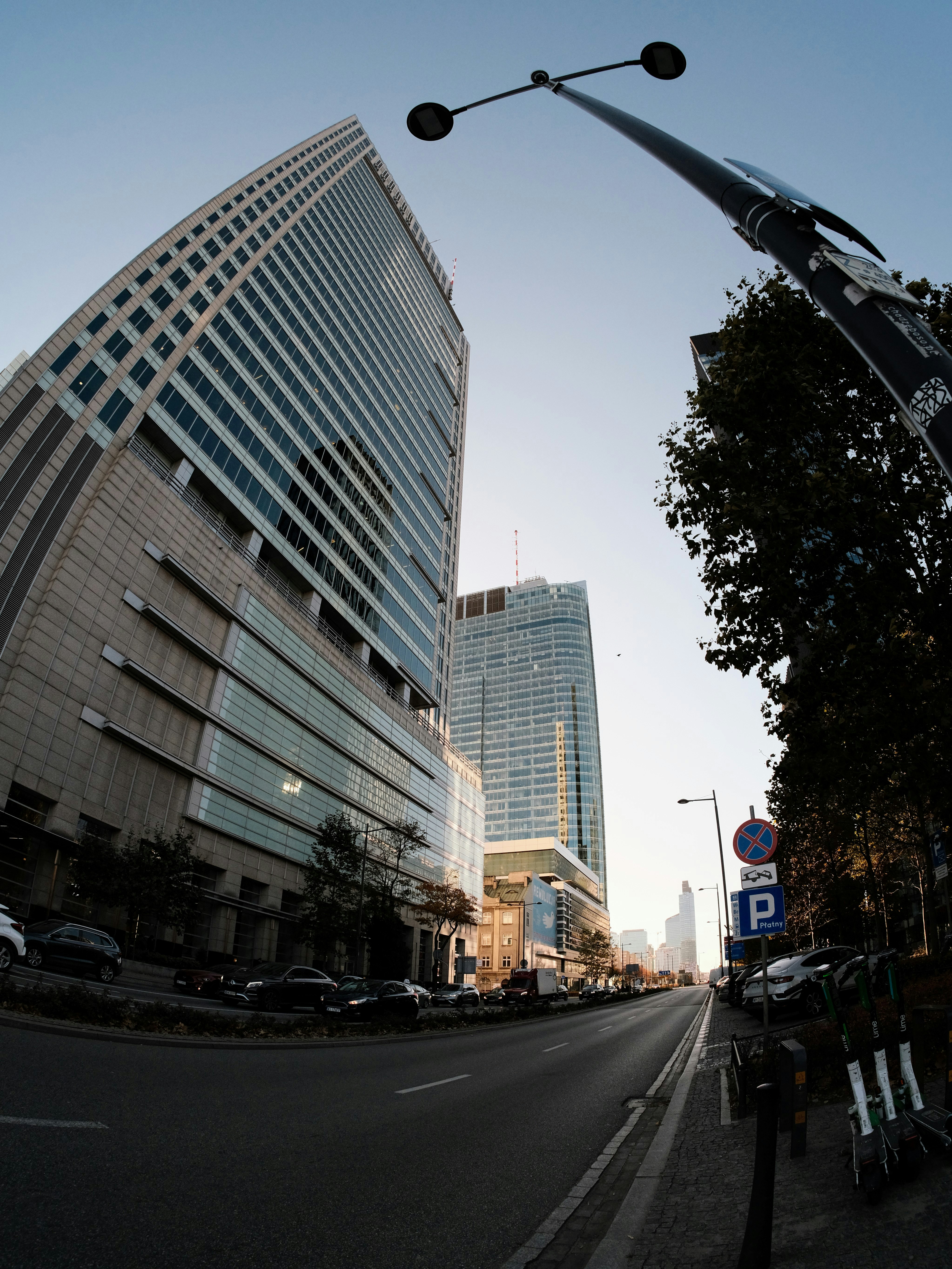 a city street with tall buildings in the background