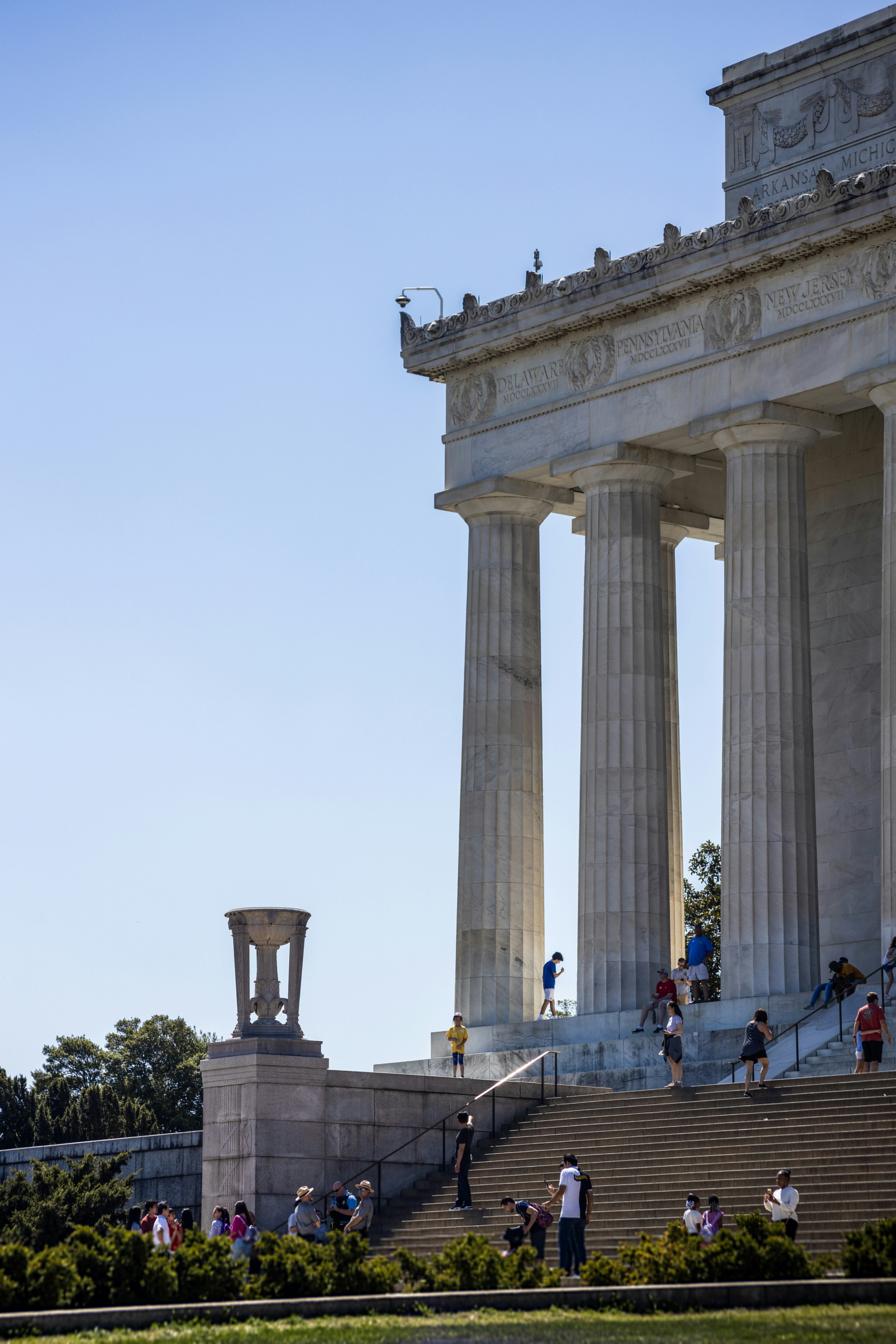 Marble Temple Steps: Visitors Climb Toward a Classical Portal