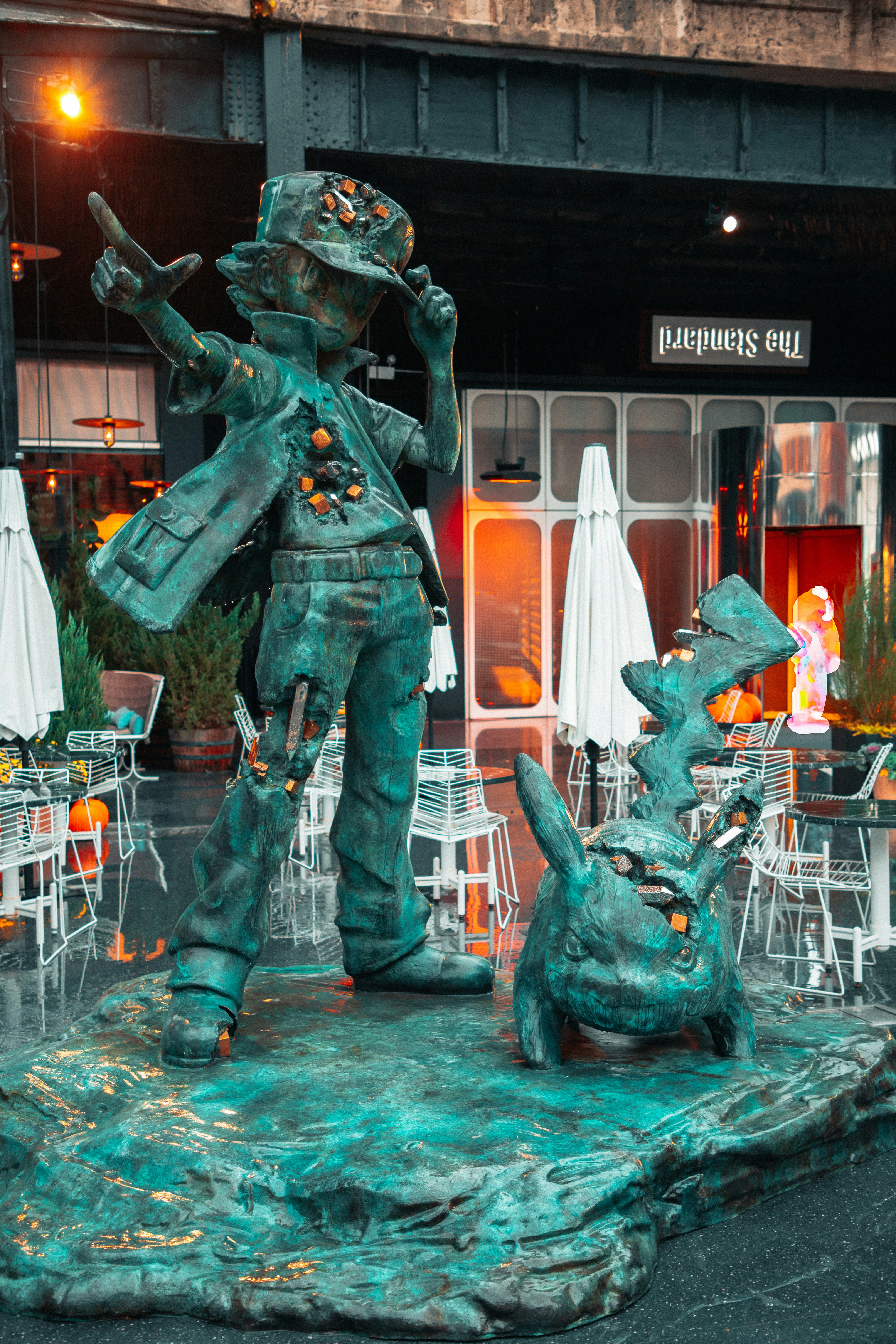 Bust of a Wandering Maestro: A Green Bronze Tale Under Neon Light