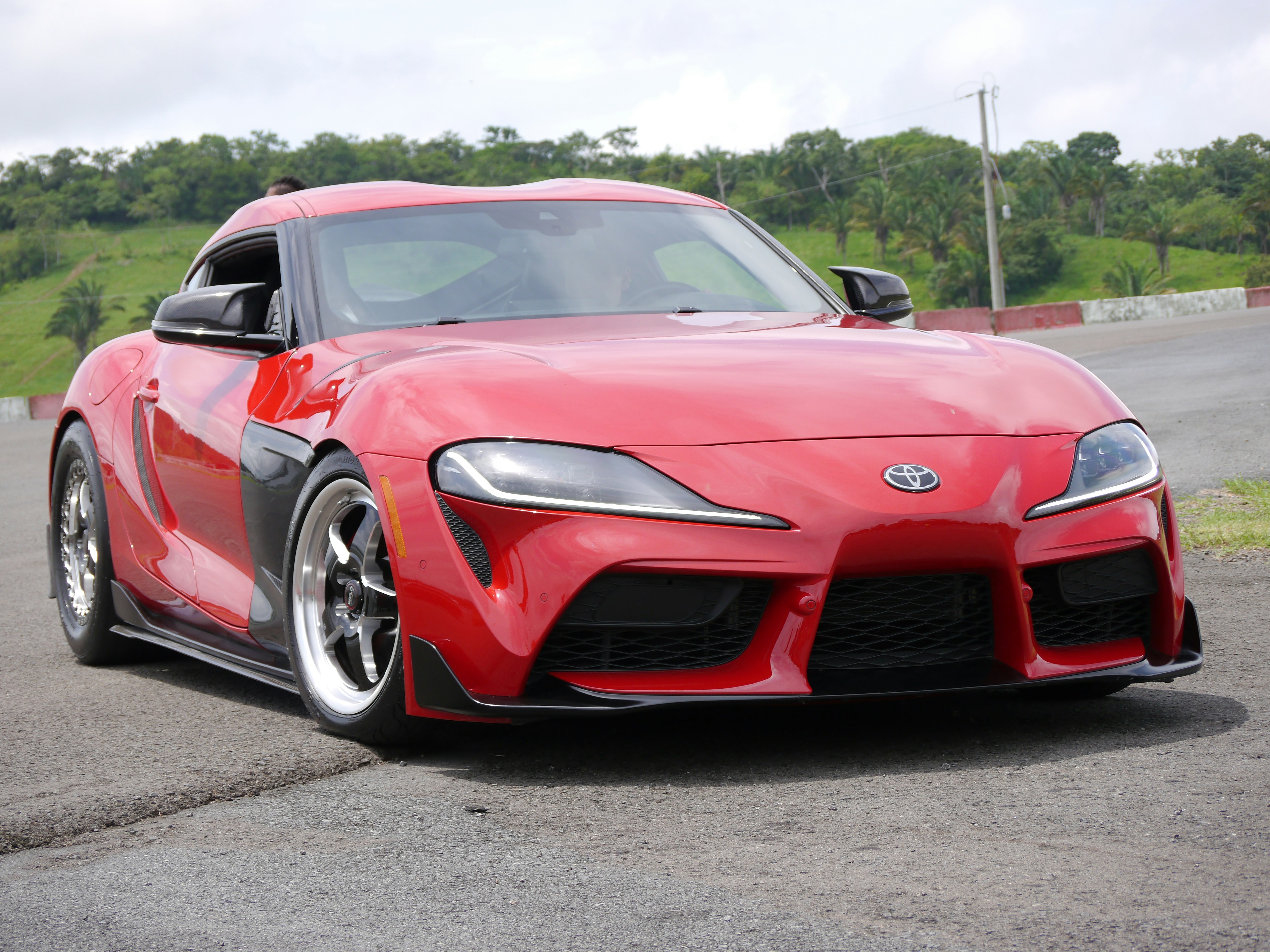 Crimson Command: Front-Quarter View of a Toyota GR Supra on a Quiet Track