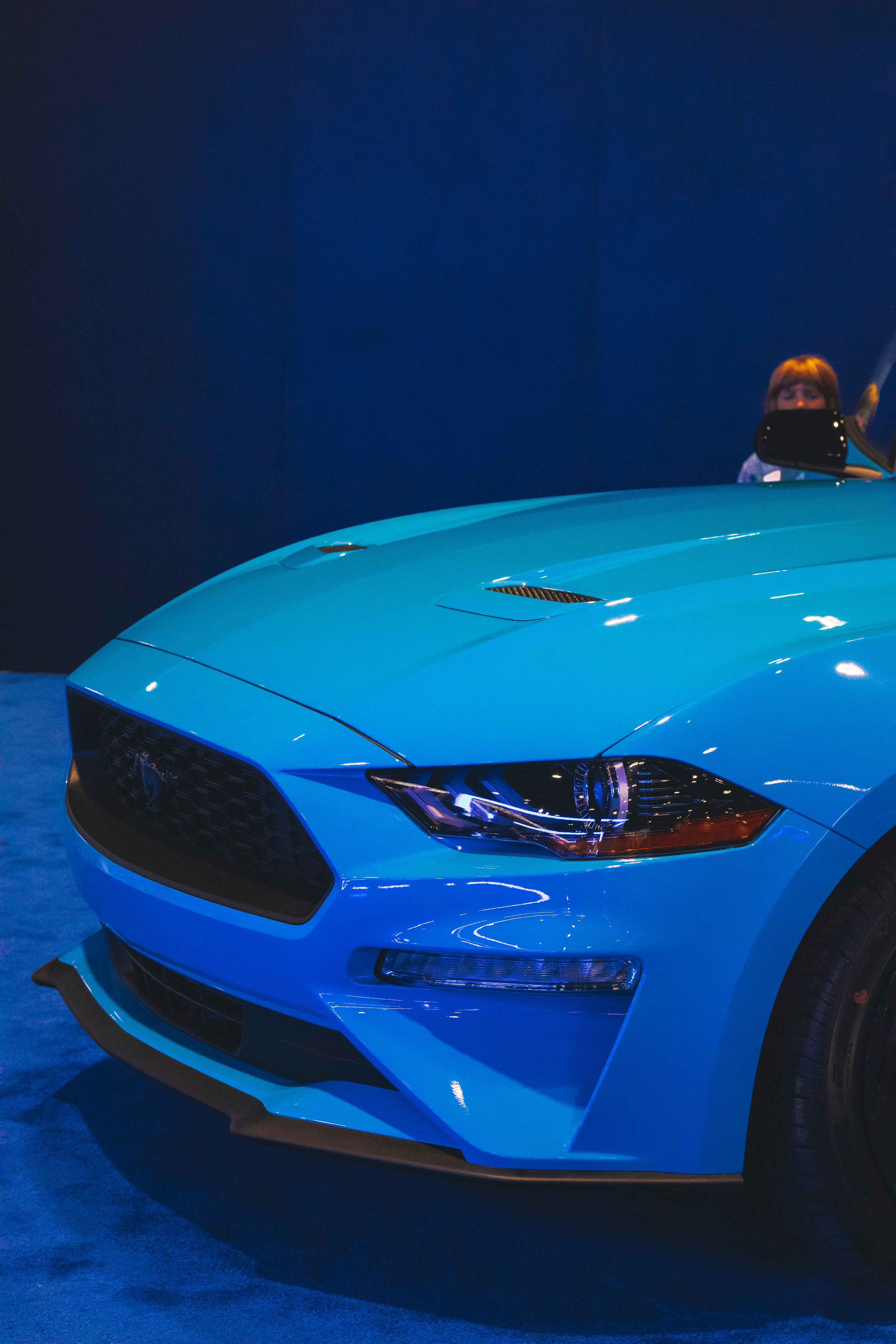 A blue sports car is on display at a car show photo – Free United ...