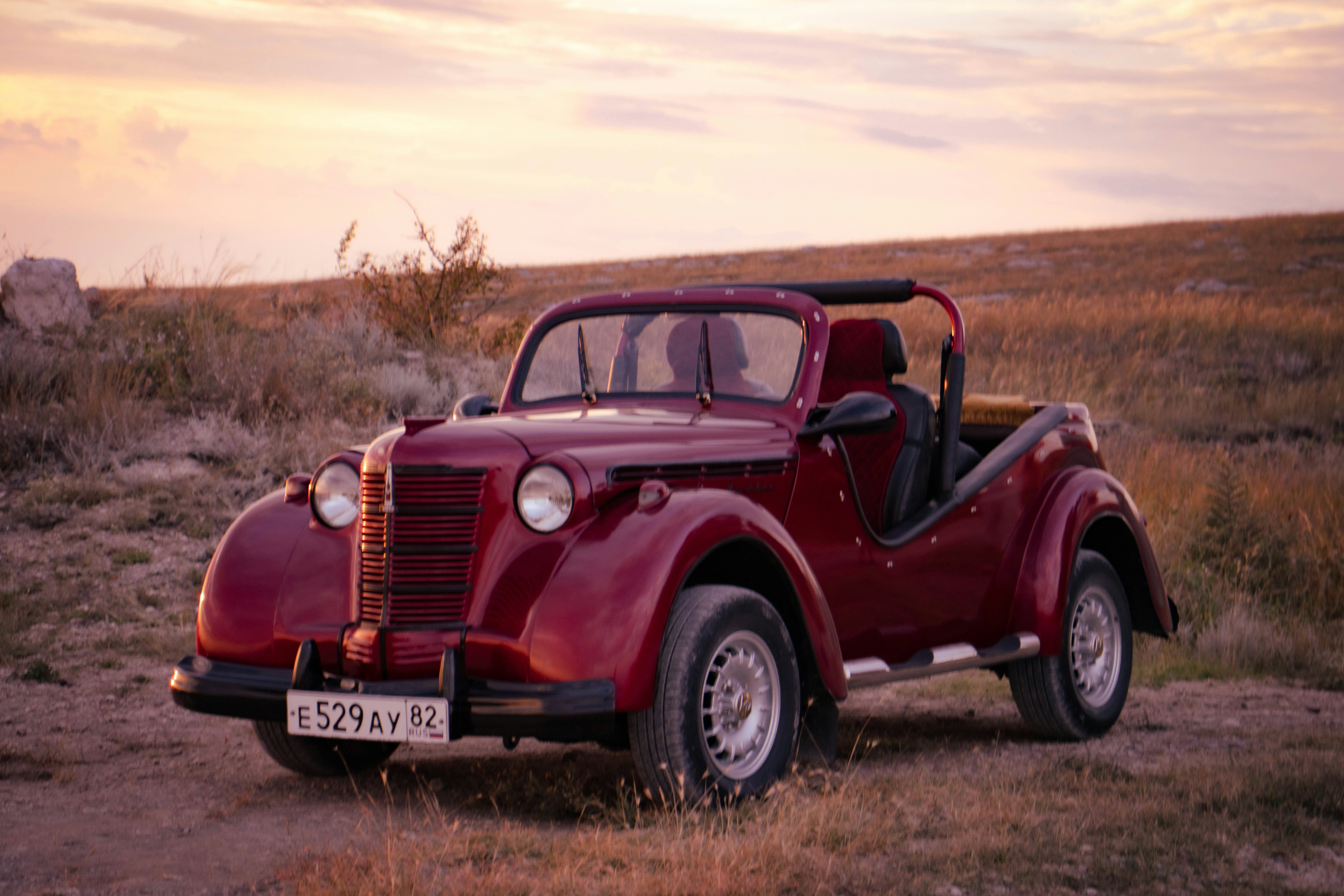 Rust Red Convertible in a Dusk-Swept Prairie
