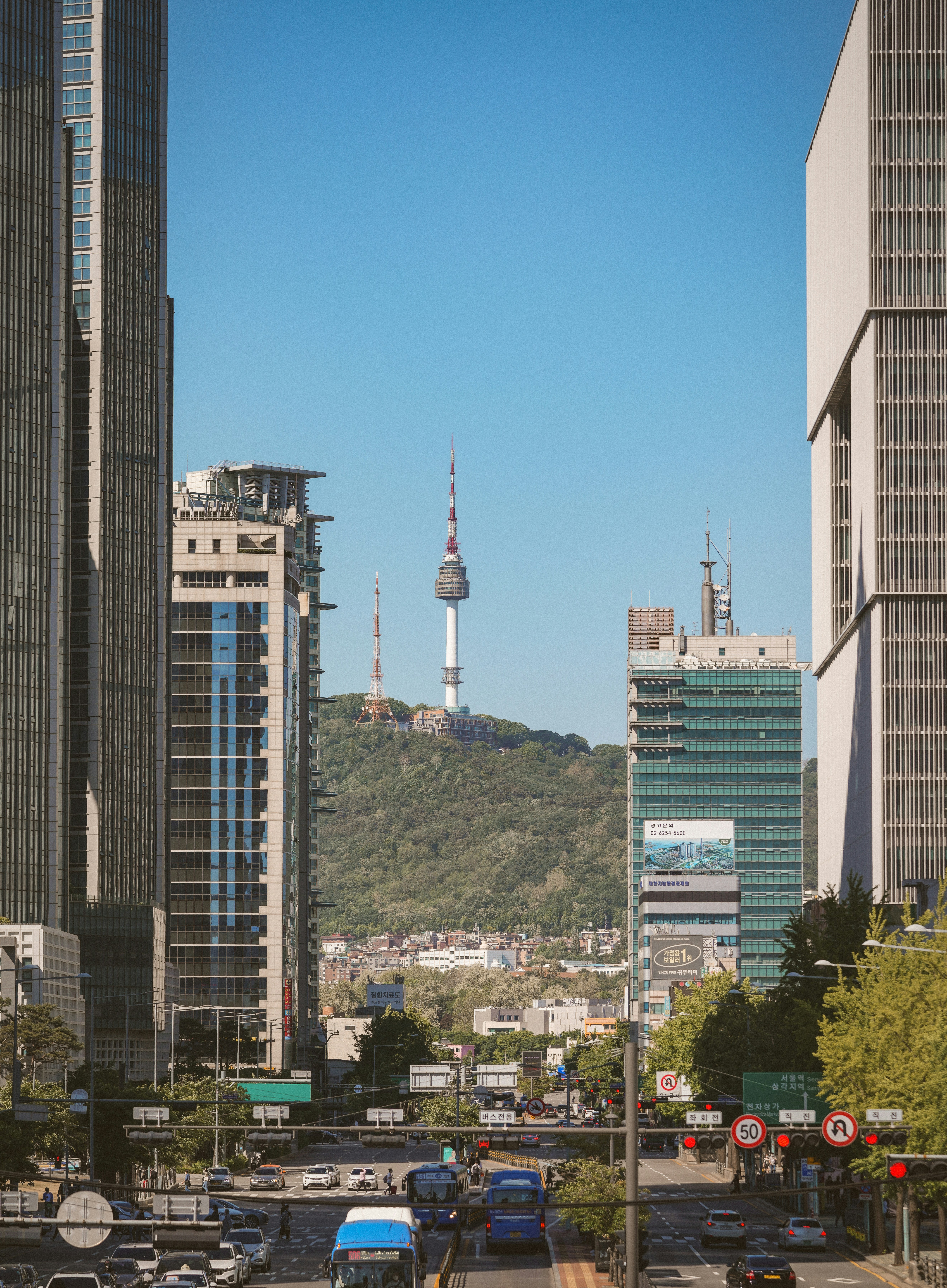 Towered Corridor: Glass, Light, and a Hilltop Skyline