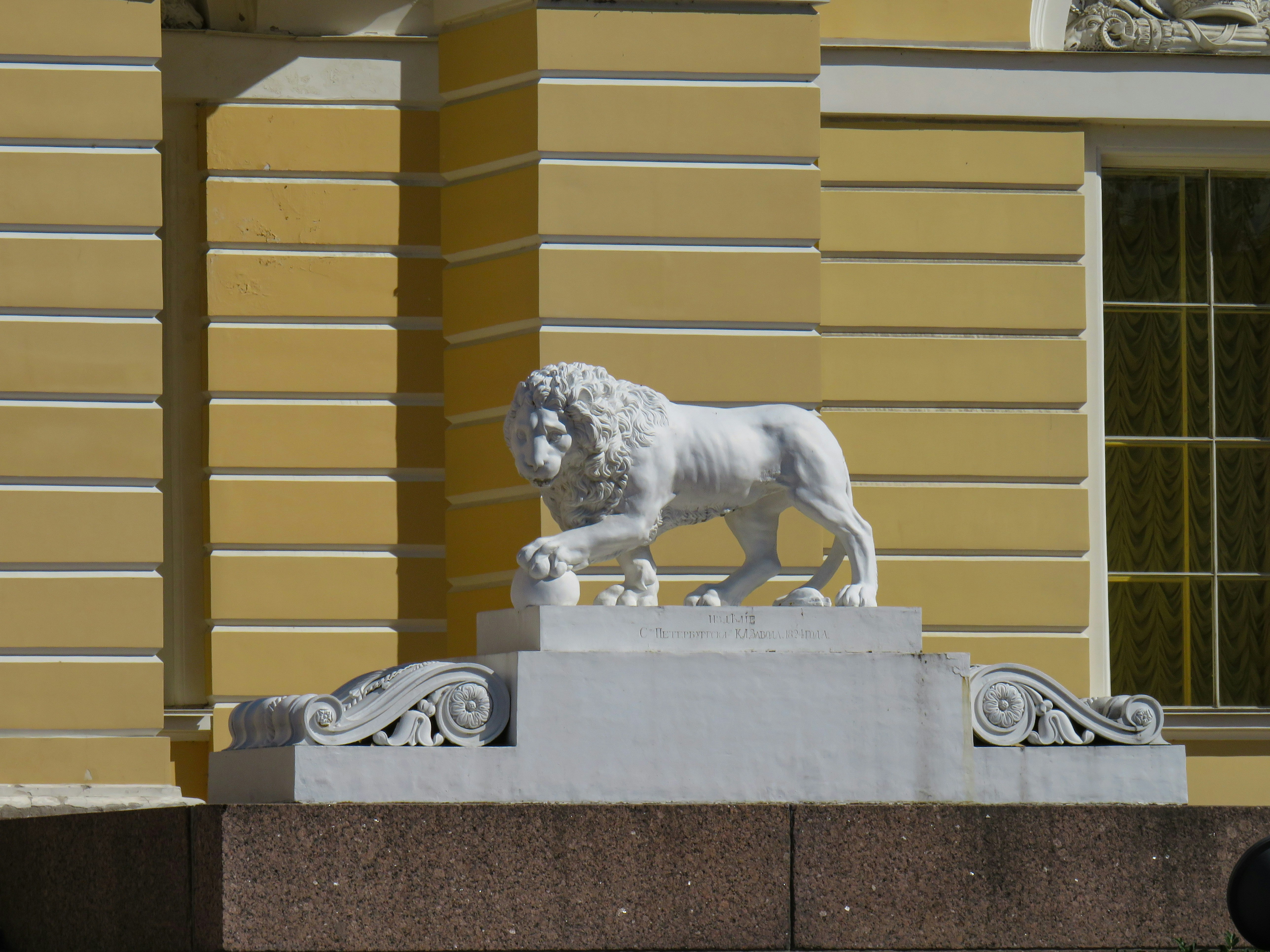 THe monument of a lion near the State Russian Museum in Saint Petersburg is under the summer sun