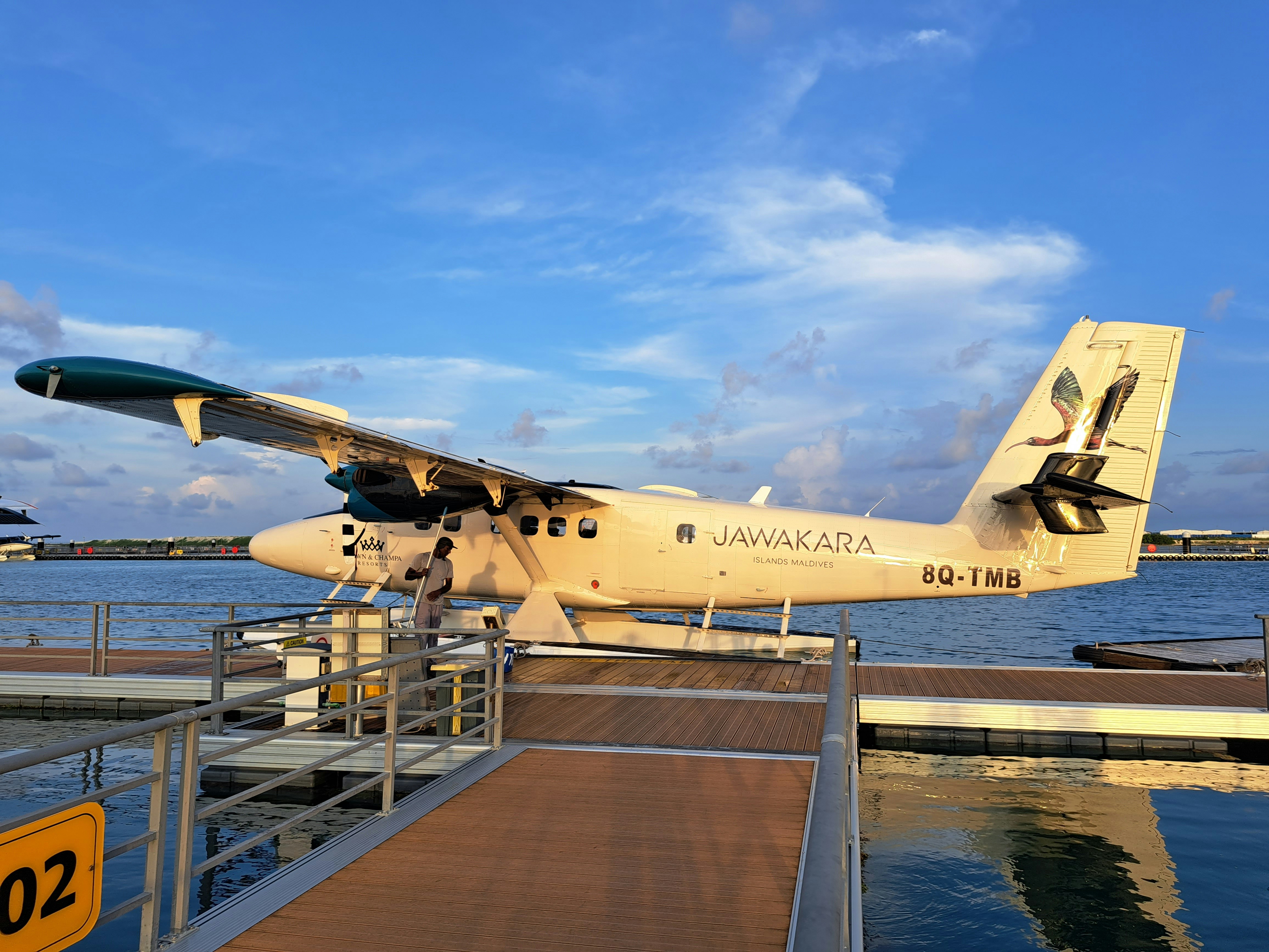 Jawakara on the Dock: A Twin-Tail Passenger Plane Beckons Across Calm Water
