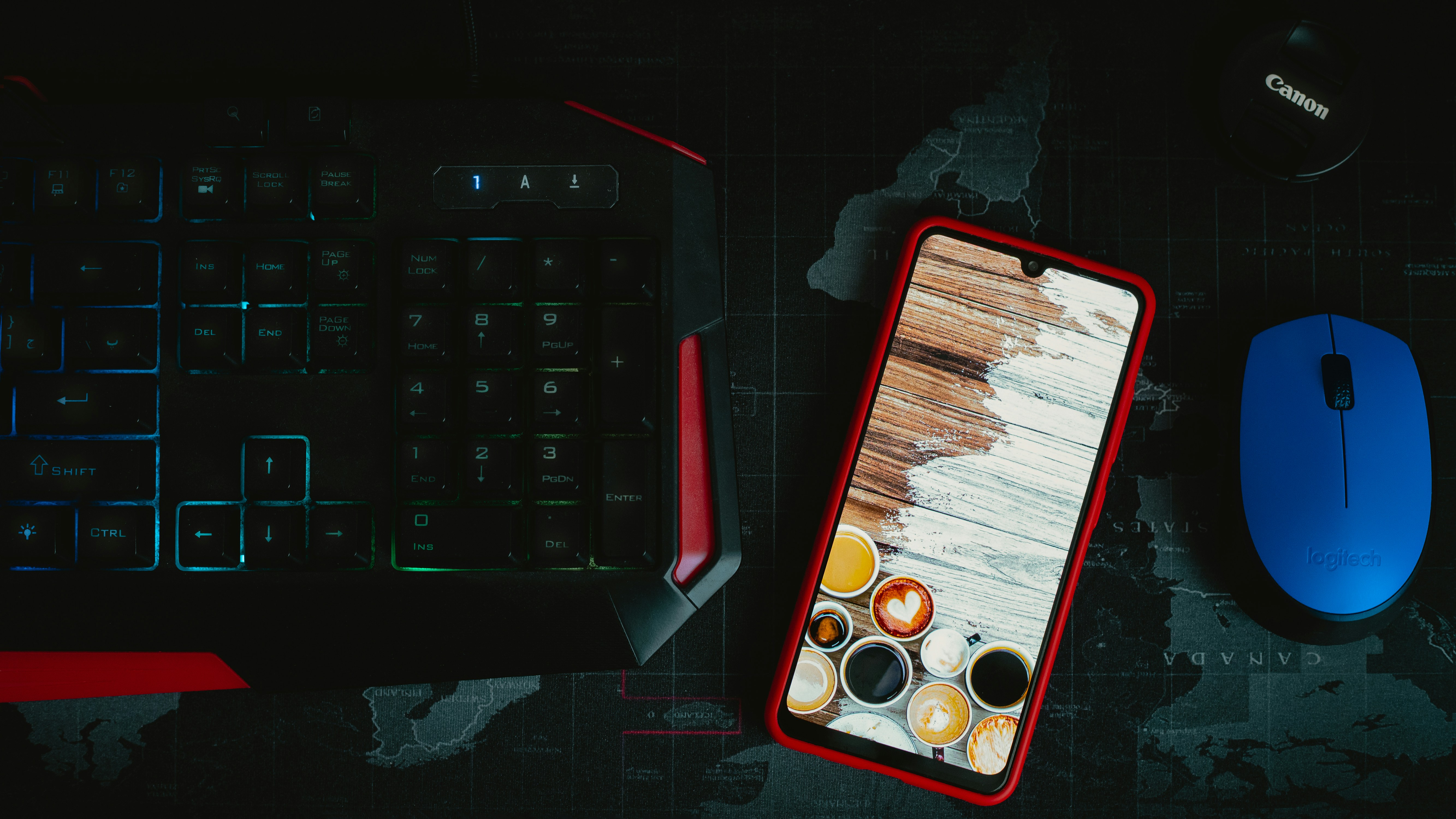Crimson iPhone as a Pocket Studio: Colorful Palette on a World Map Desk