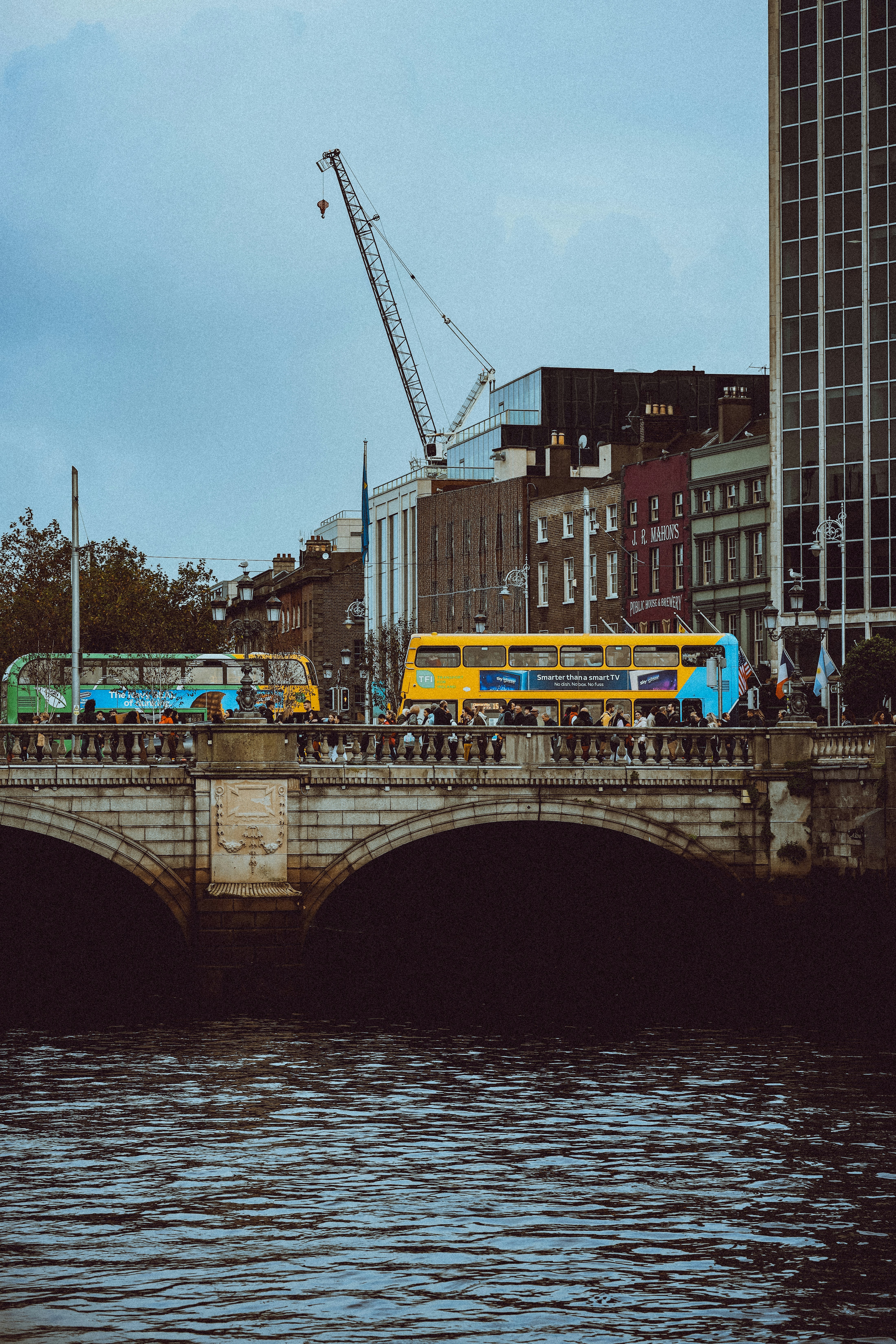 Riverside Transit: Yellow Double-Decker Crossing the City Bridge