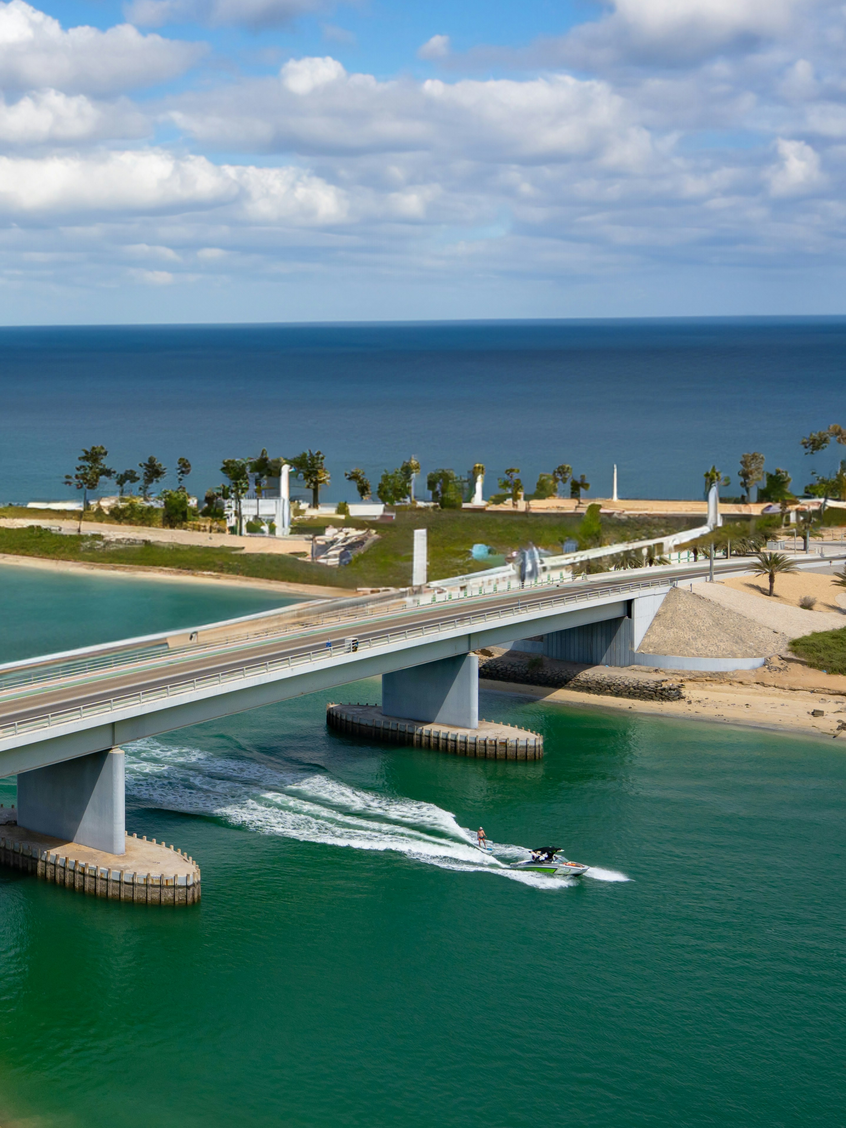 Crossing Light: Jet-Ski Ripples Beneath a Coastal Bridge