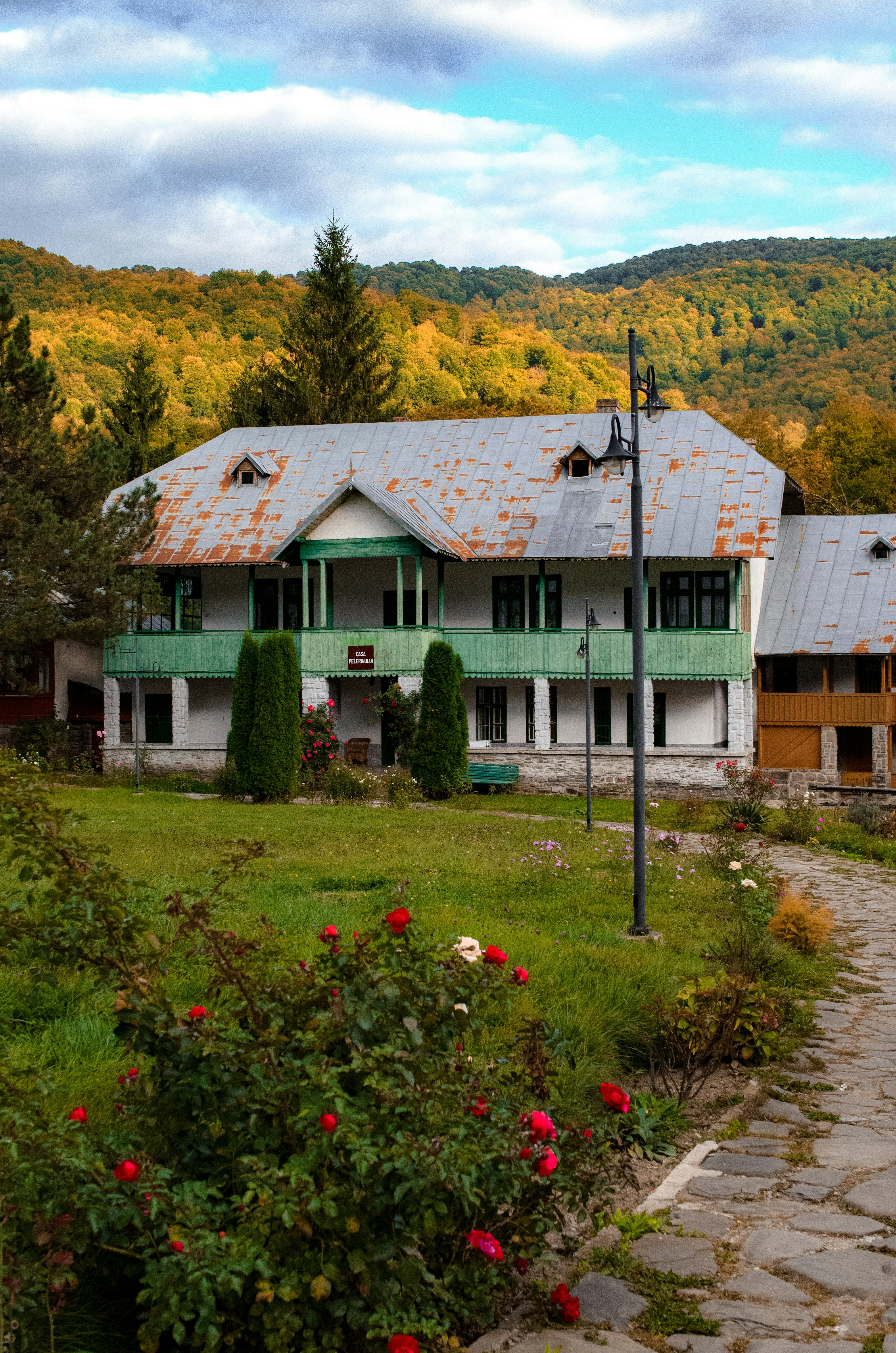 A house with a red rose bush in front of it photo – Free Mânăstirea ...