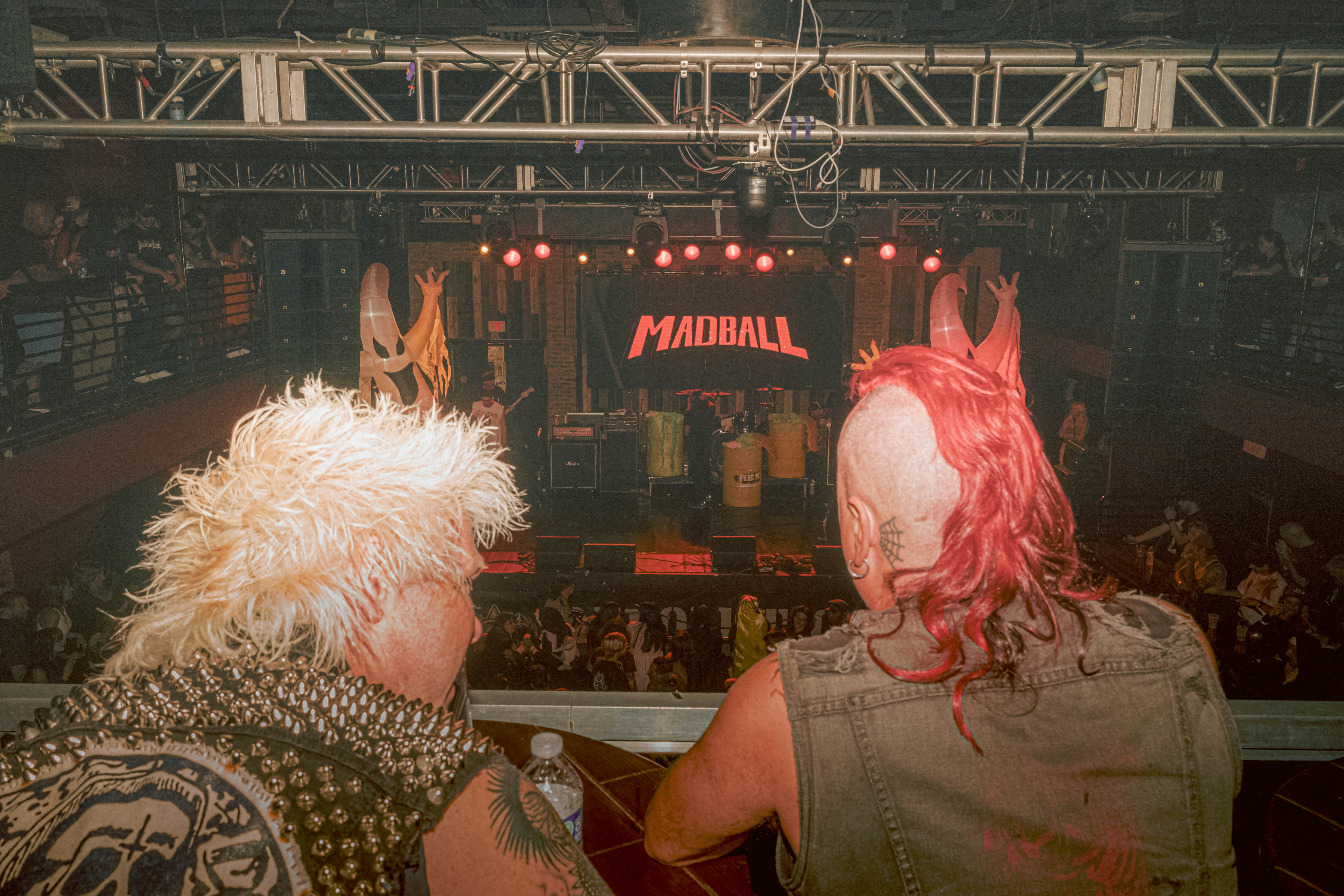 Balcony Gaze: Two Punks Stand Against the Rail as Madball Lights Up the Night