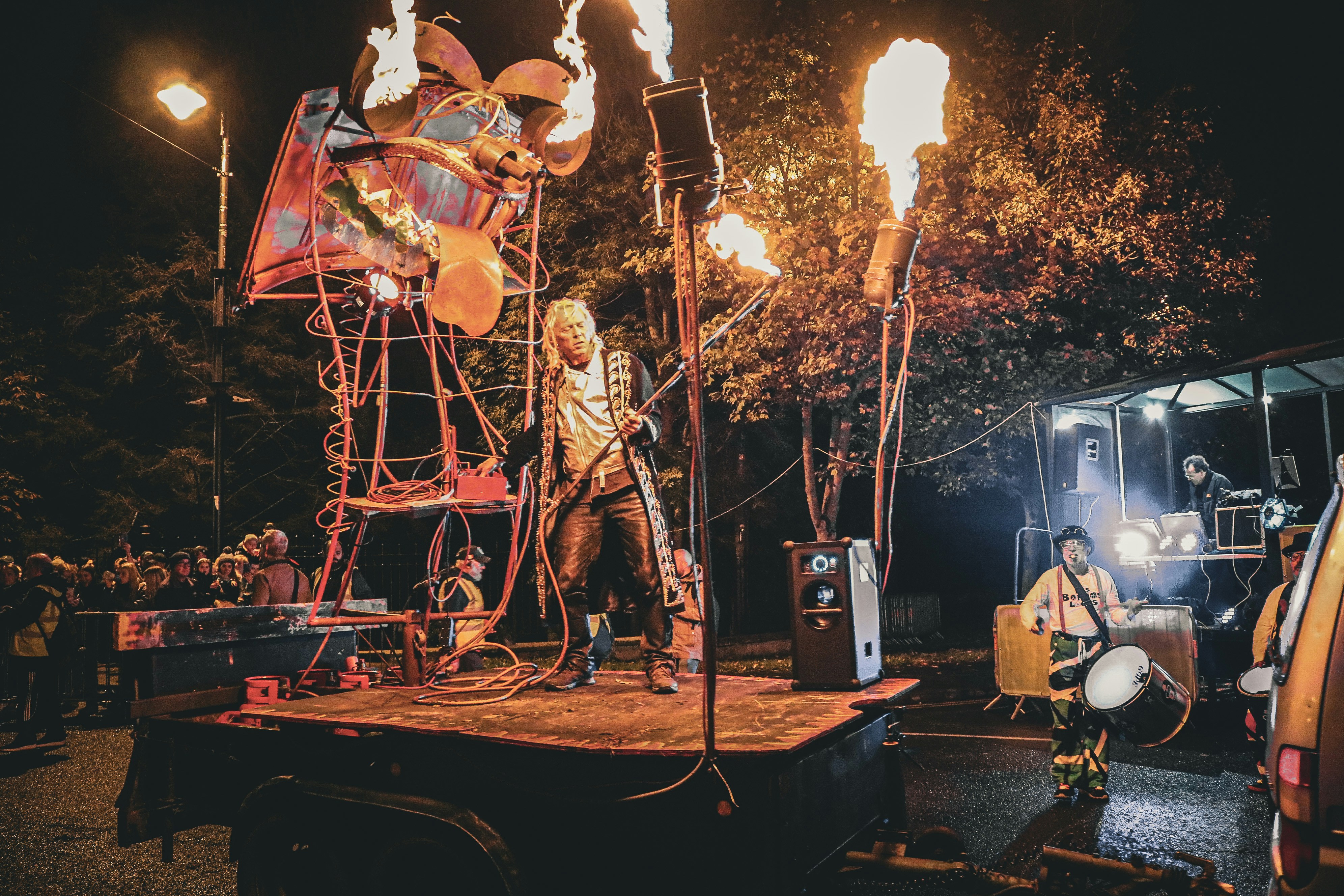 A man standing on top of a stage surrounded by fire photo – Free ...