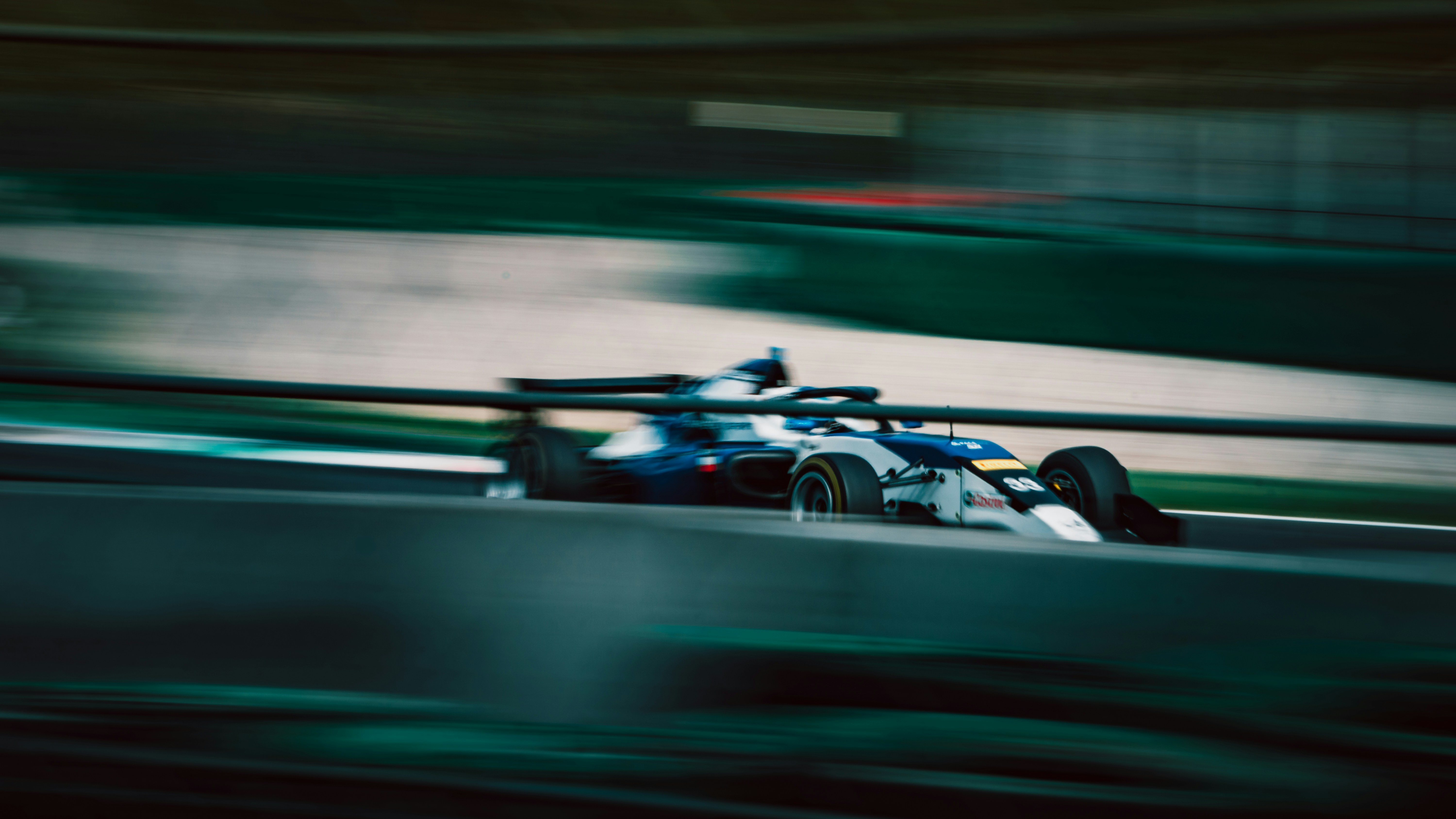 A racing car driving on a track in motion photo – Free Autodromo ...