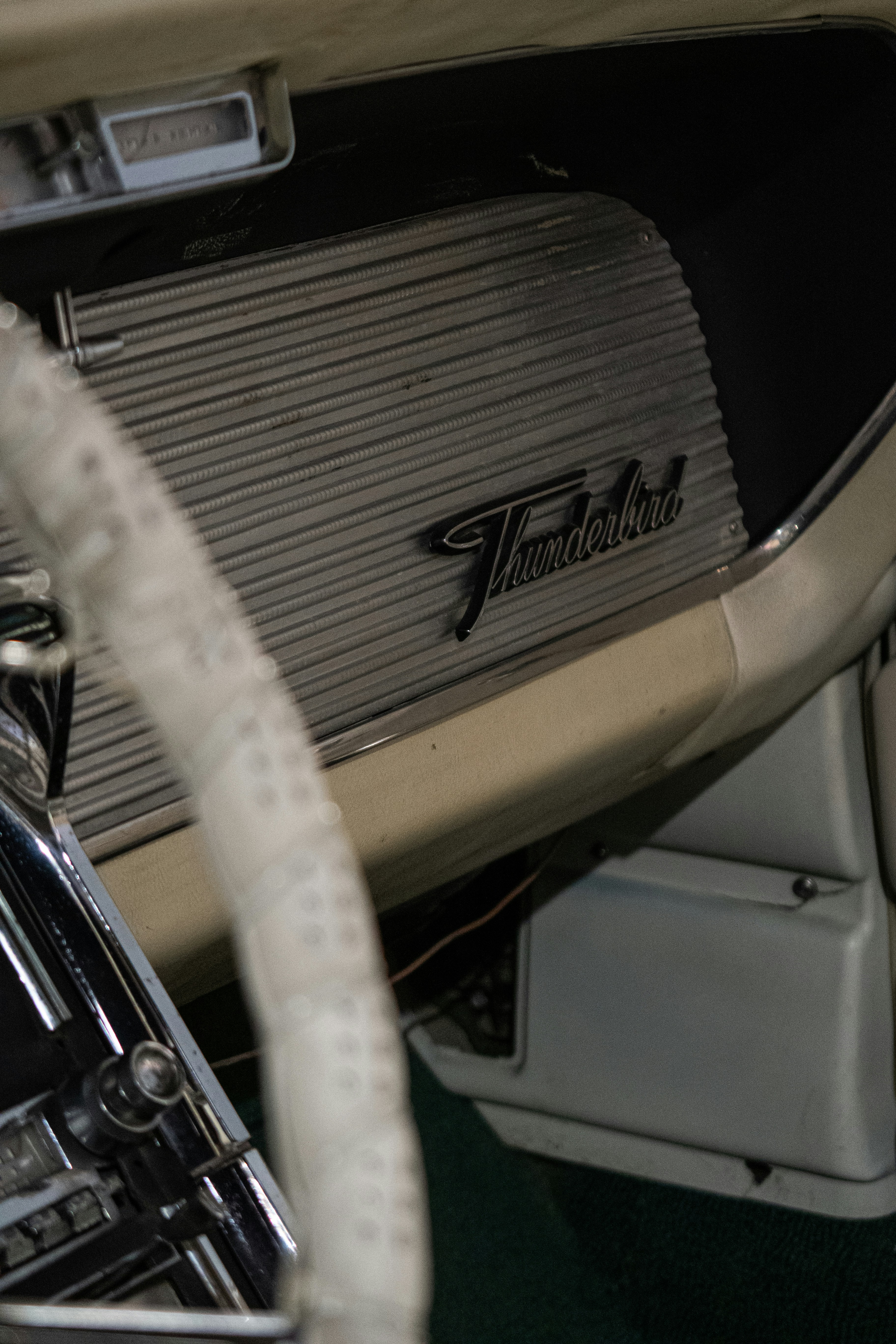 Thunderbird Emblem Nestled in a Vintage Car Cabin
