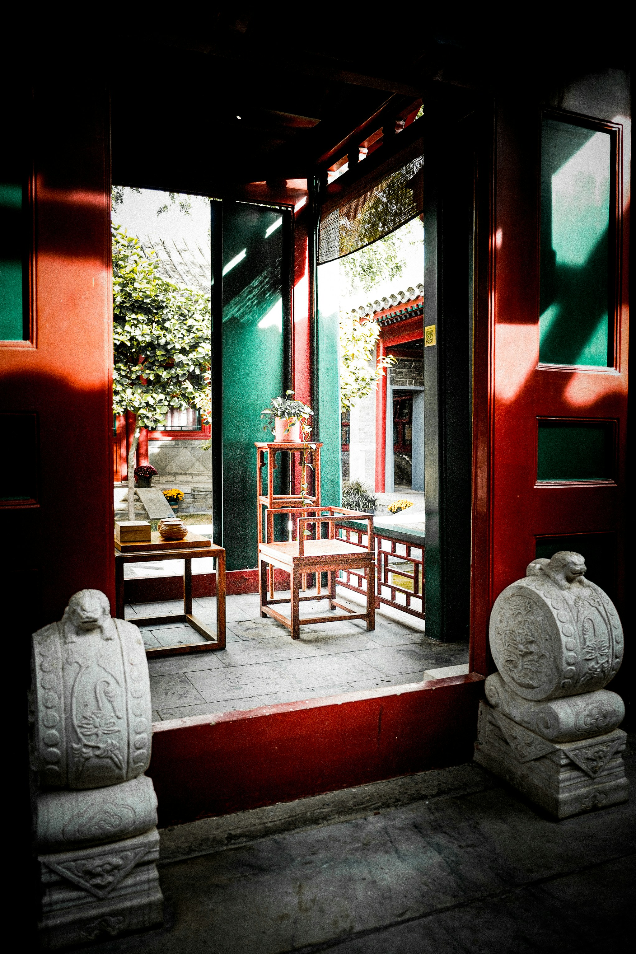 Red Sanctuary Doorway: An Interior Courtyard Framed by Stone Carvings